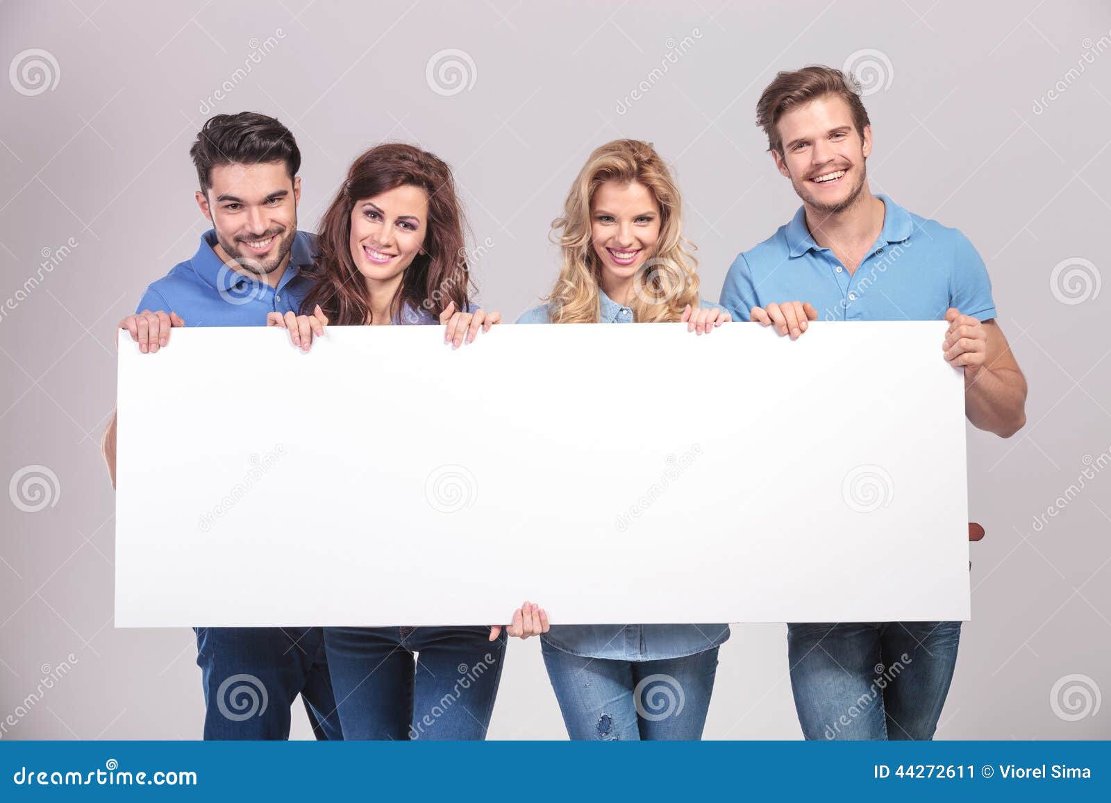 Casual Group of Young People Holding a Big Blank Board Stock Image ...
