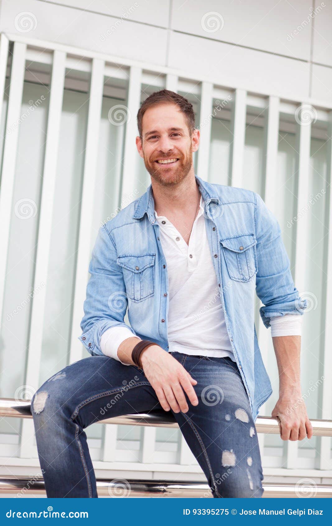 Casual Guy Sitting on a Railing in the Street Stock Image - Image of ...
