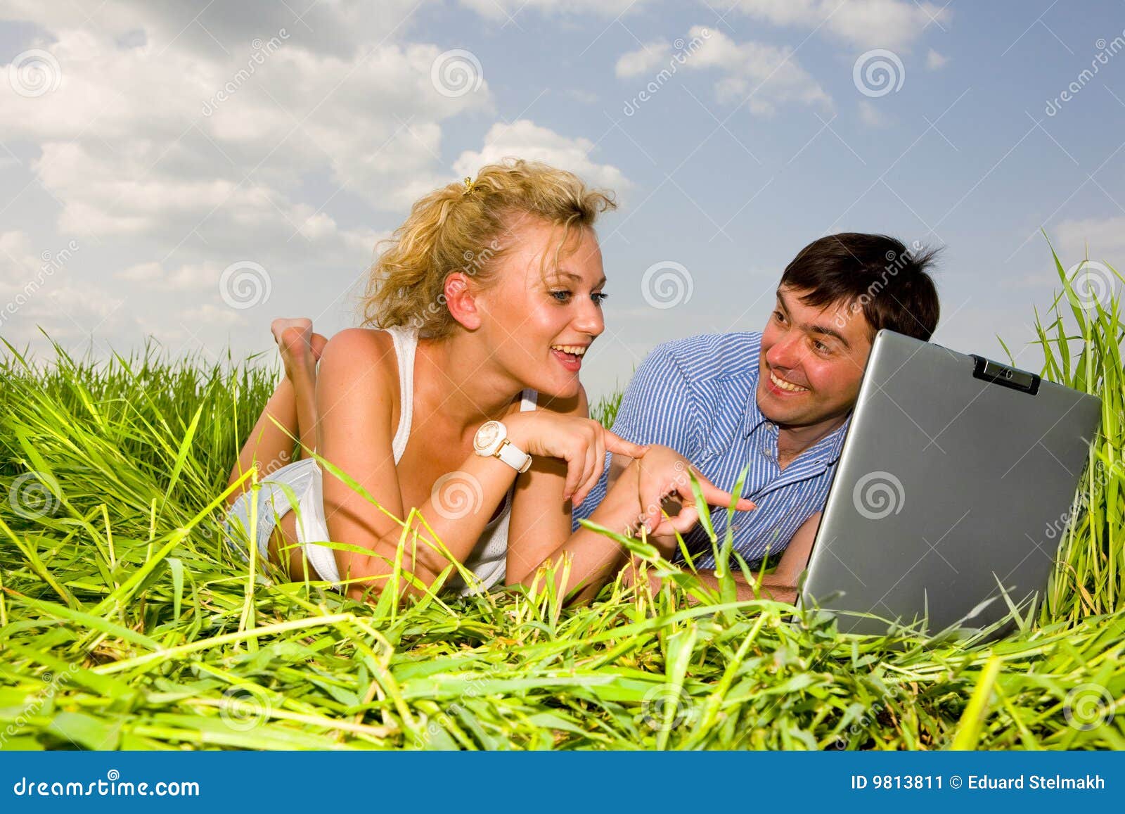 Casual Happy Couple on a Laptop Computer Outdoors Stock Image - Image ...