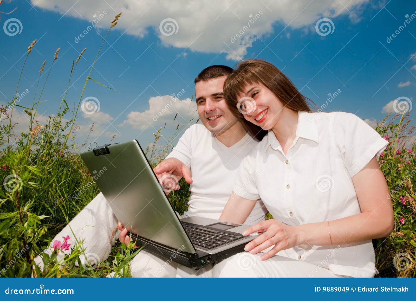 Casual Happy Couple on a Laptop Computer Outdoors Stock Image - Image ...