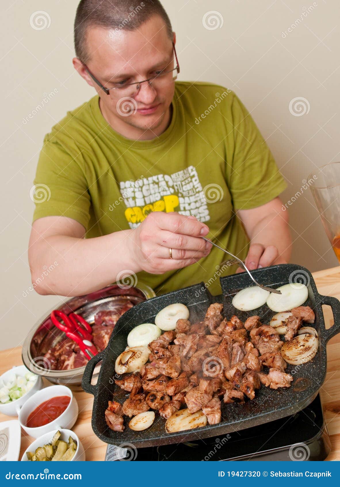 Casual man cooking meat stock photo. Image of black, home - 19427320