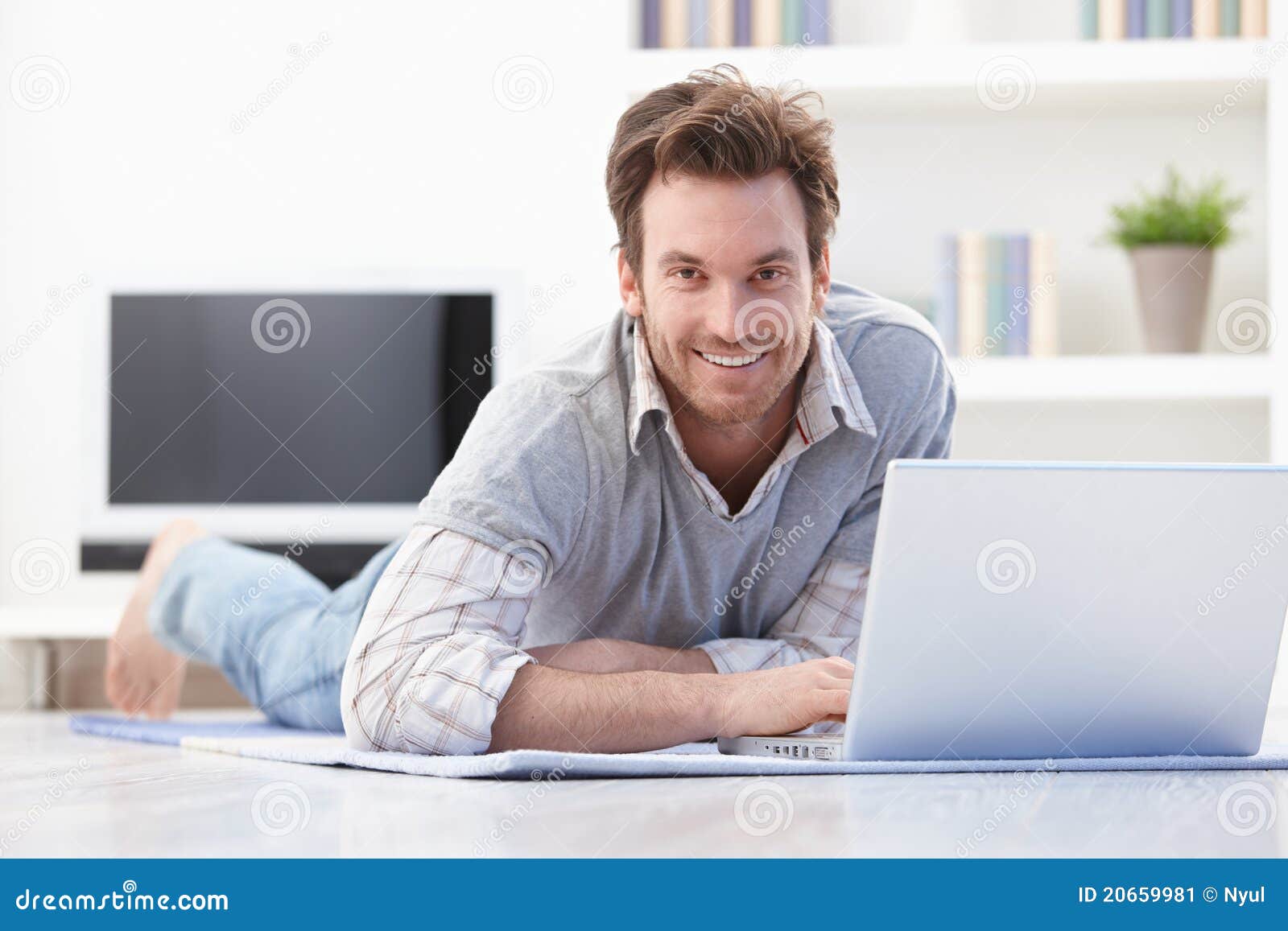 Casual Man Laying on Floor at Home Smiling Stock Image - Image of alone ...