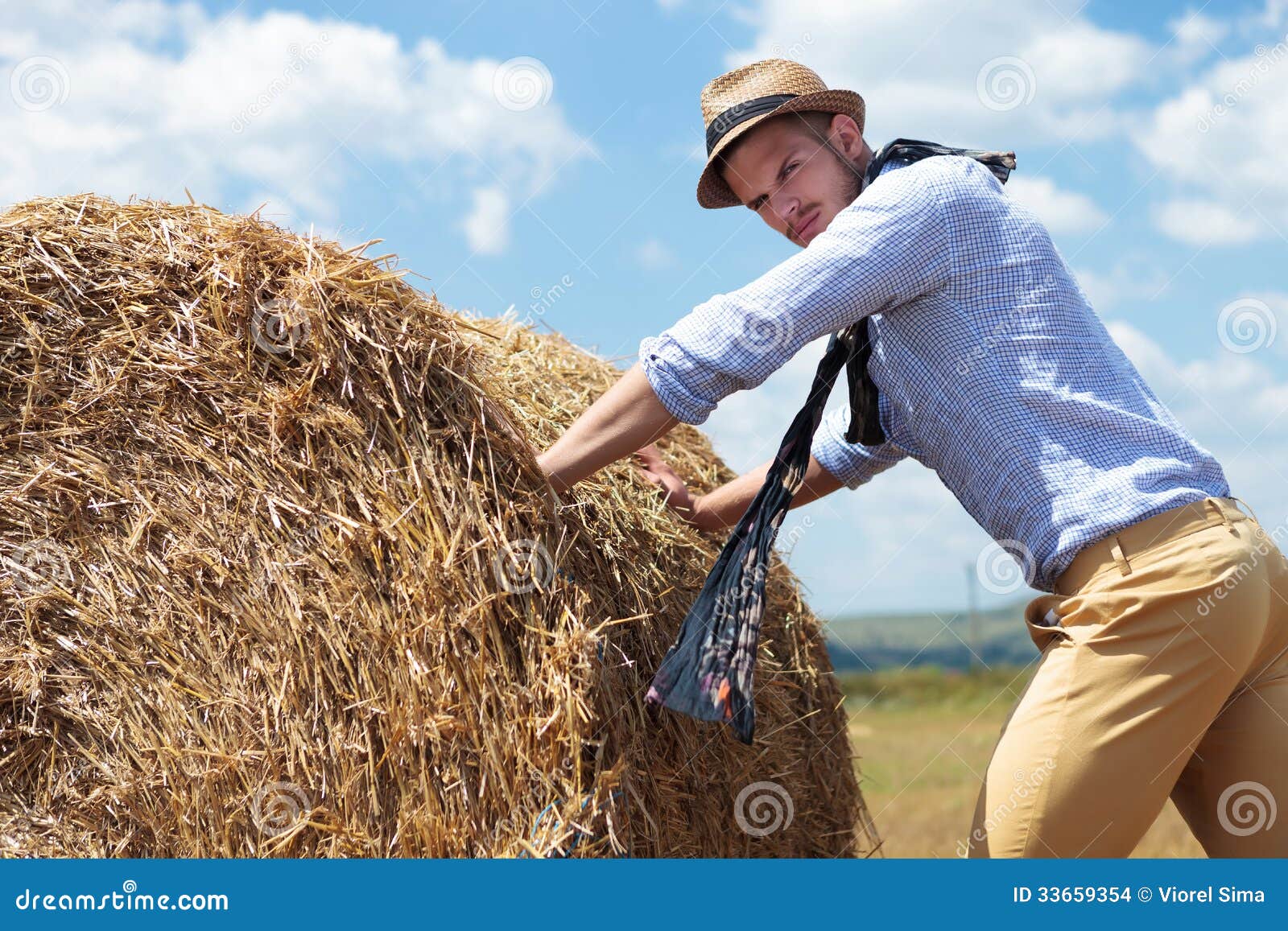 Casual Man Outdoor Pushing a Big Round Haystack Stock Photo - Image of ...