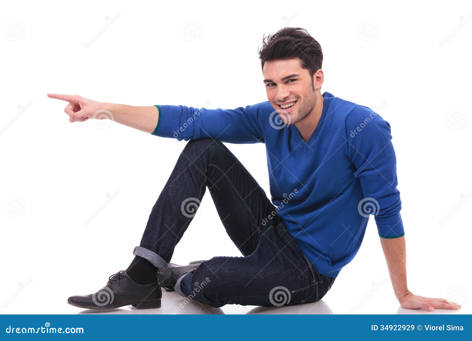 Casual Man is Pointing To His Side while Sitting Stock Image - Image of ...