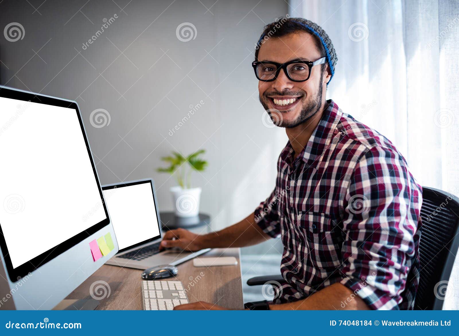 Casual Man Posing for Camera at Computer Desk Stock Photo - Image of ...