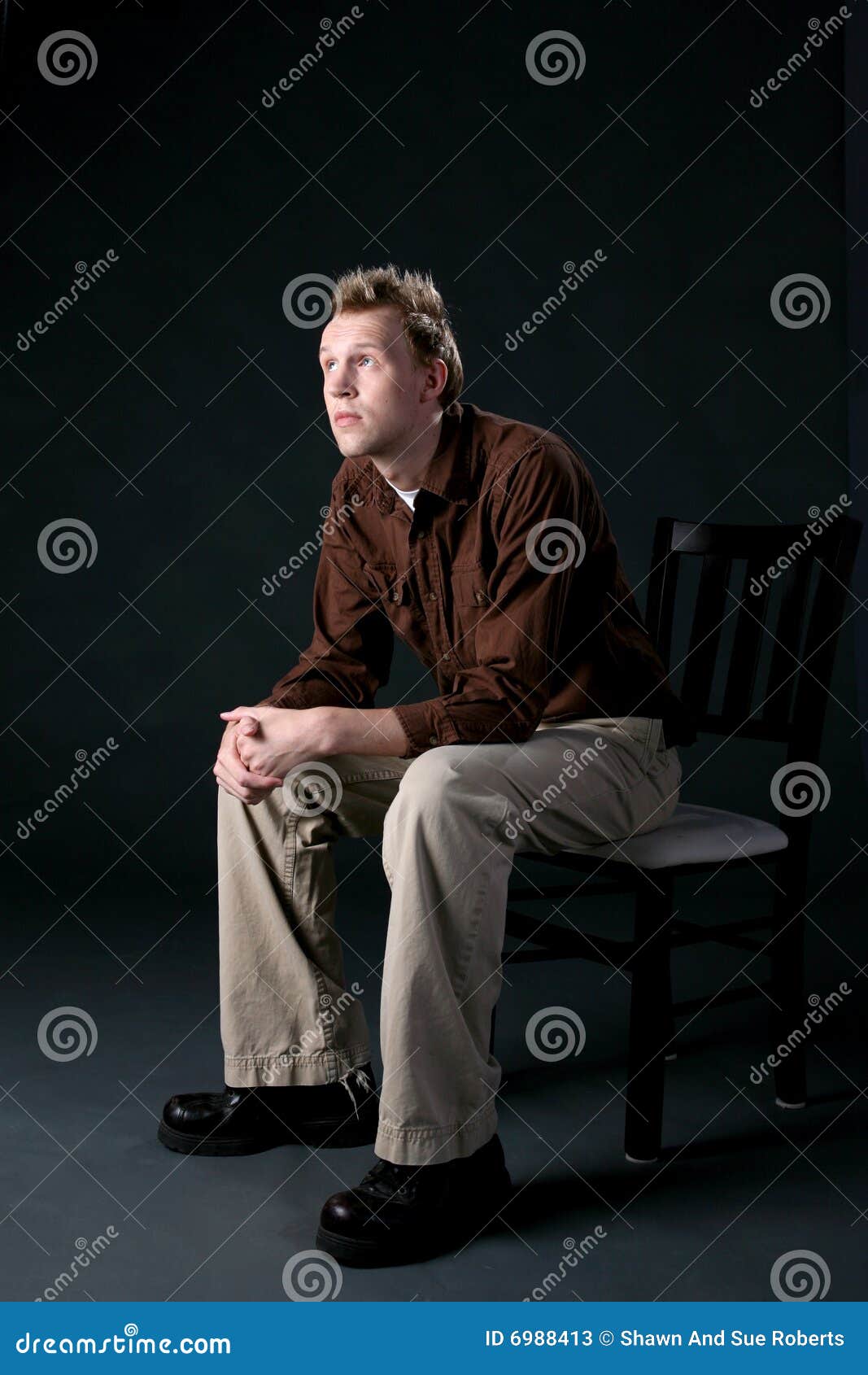 Casual Man Sitting in a Chair and Looking Up Stock Image - Image of ...