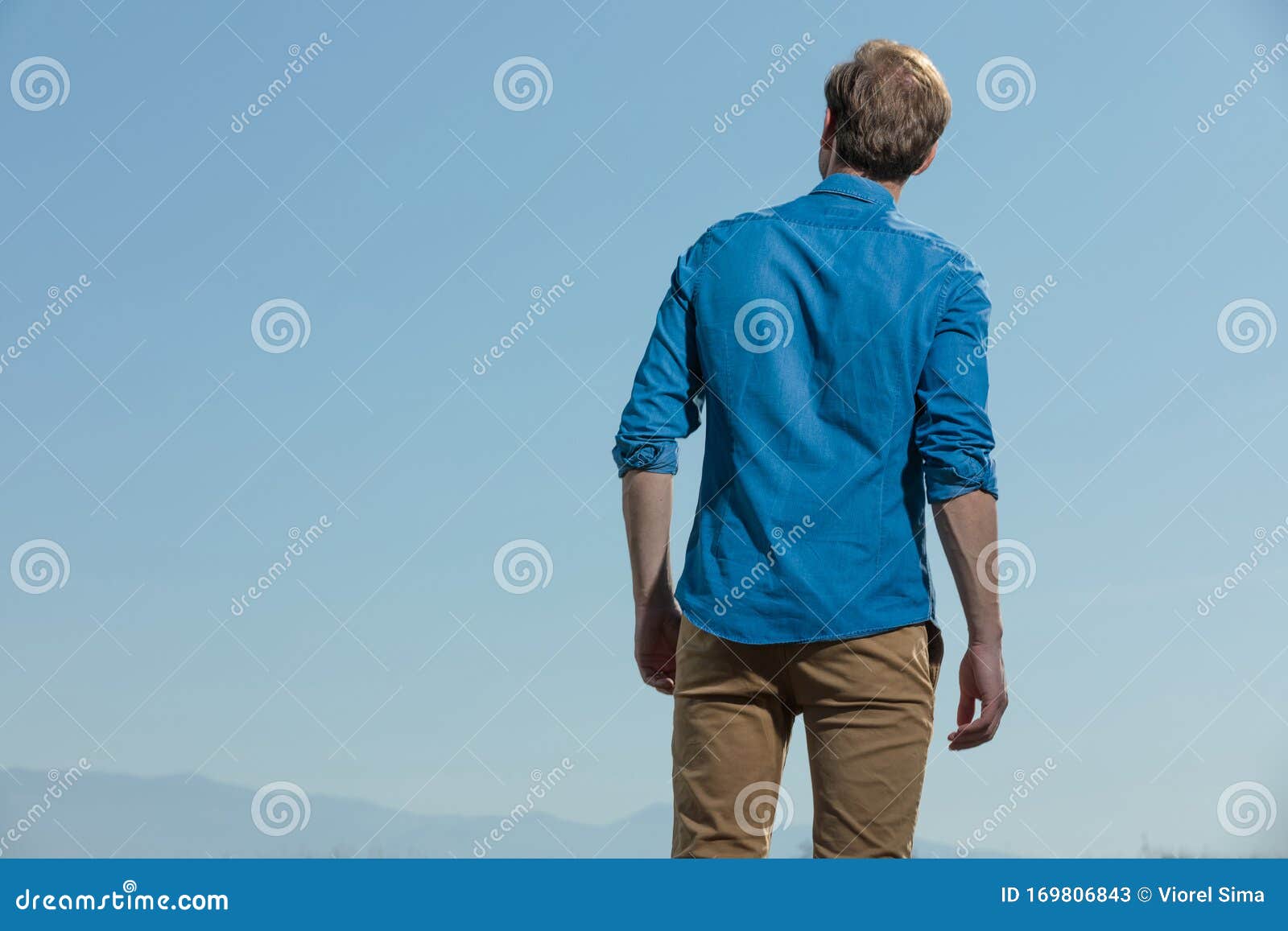Casual Man Standing Relaxed with Hands Loose and Looking Away Stock ... Casual Man Standing Relaxed with Hands Loose and Looking Away Stock ...