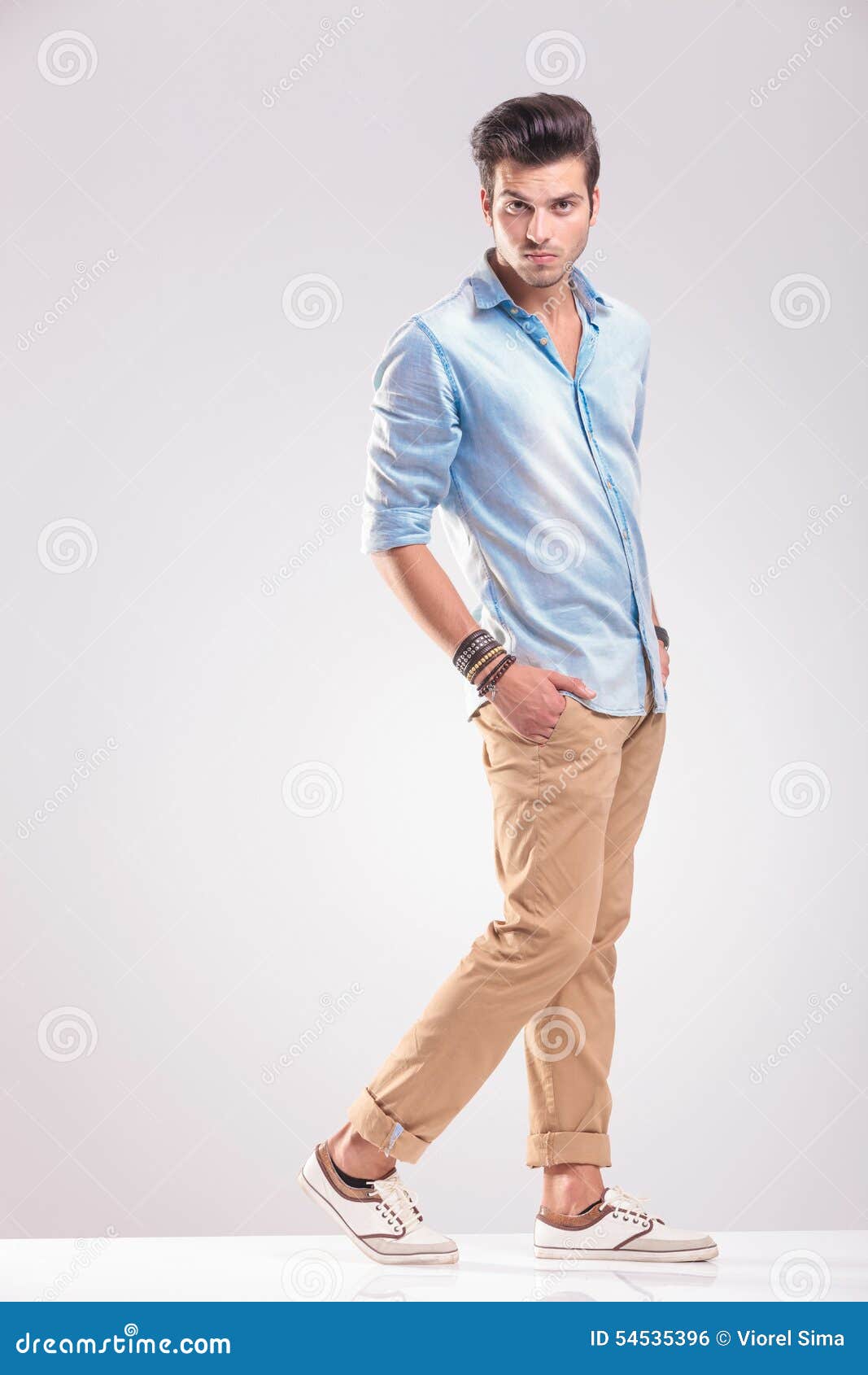 Casual Man Walking with His Hands in Pockets Stock Photo - Image of ...