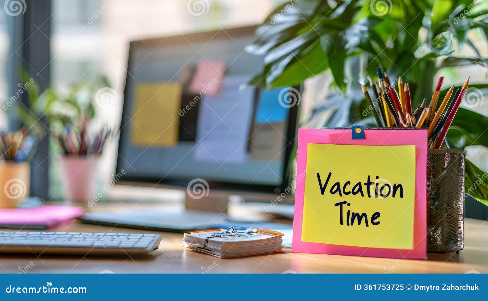 Casual Office Desk Setup with a Colorful Sticky Note Reading Vacation ...