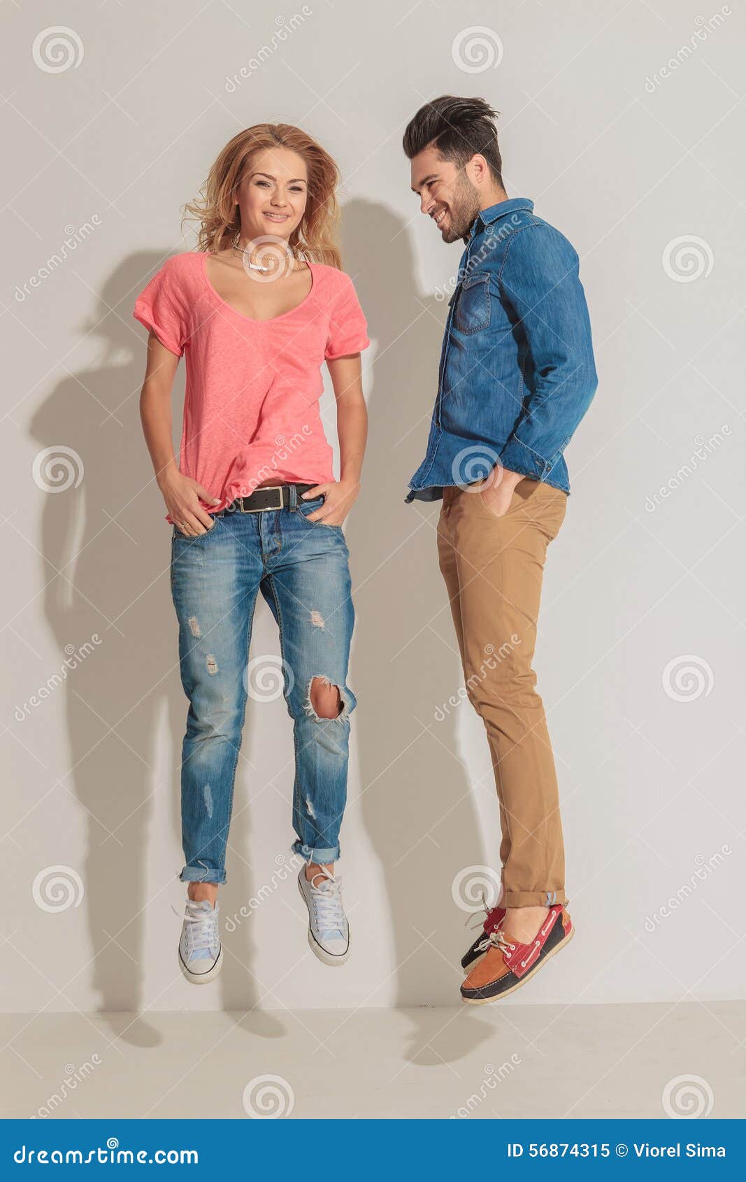 Casual Young Couple Jumping Together Stock Image - Image of girlfriend ...