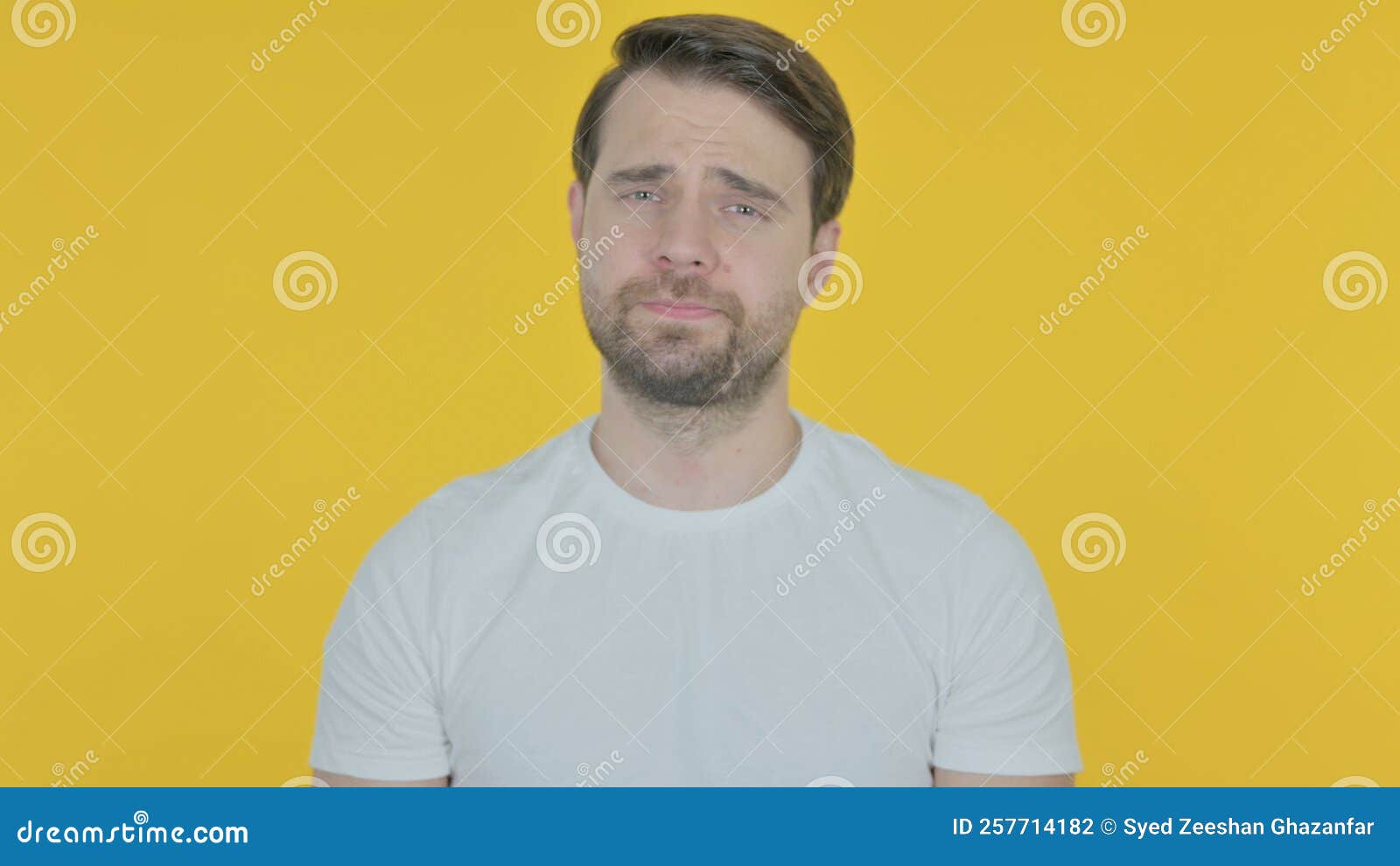 Young Man Shaking Head in Denial on Yellow Background Stock Photo ...