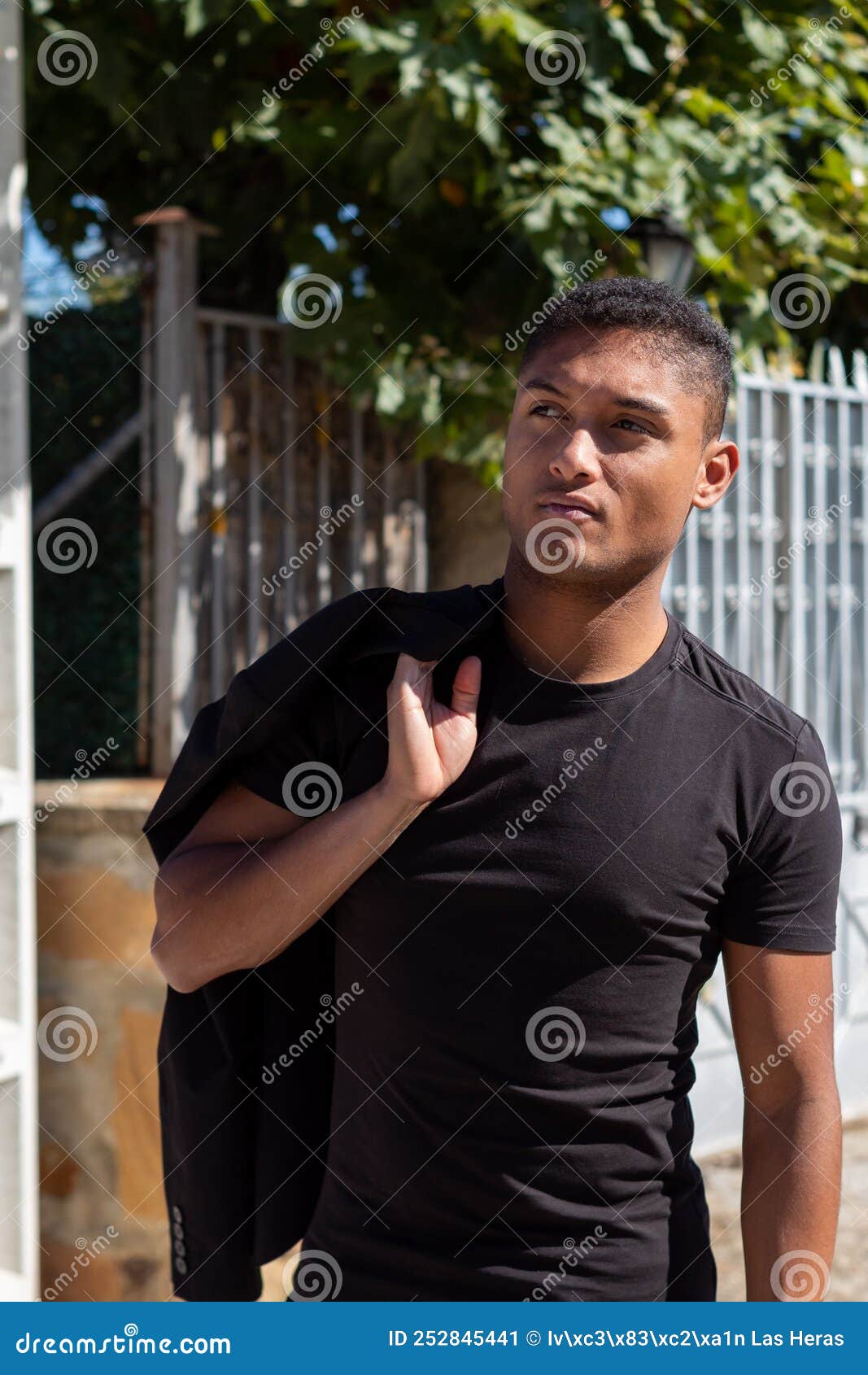 Casual Young Man with Jacket on Shoulder Looking Away Stock Image ...