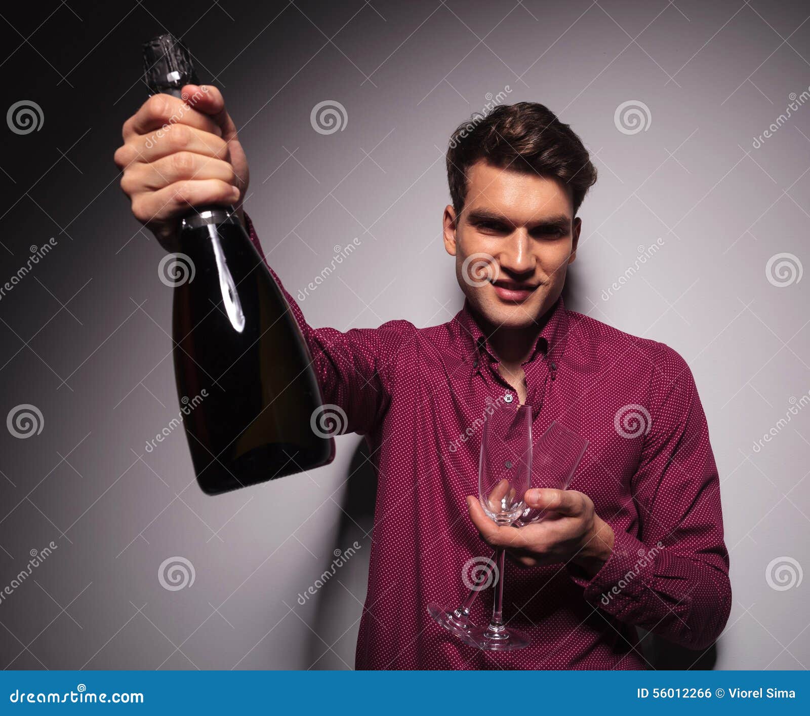Casual Young Man Presenting a Bottle of Wine Stock Photo - Image of ... Casual Young Man Presenting a Bottle of Wine Stock Photo - Image of ...