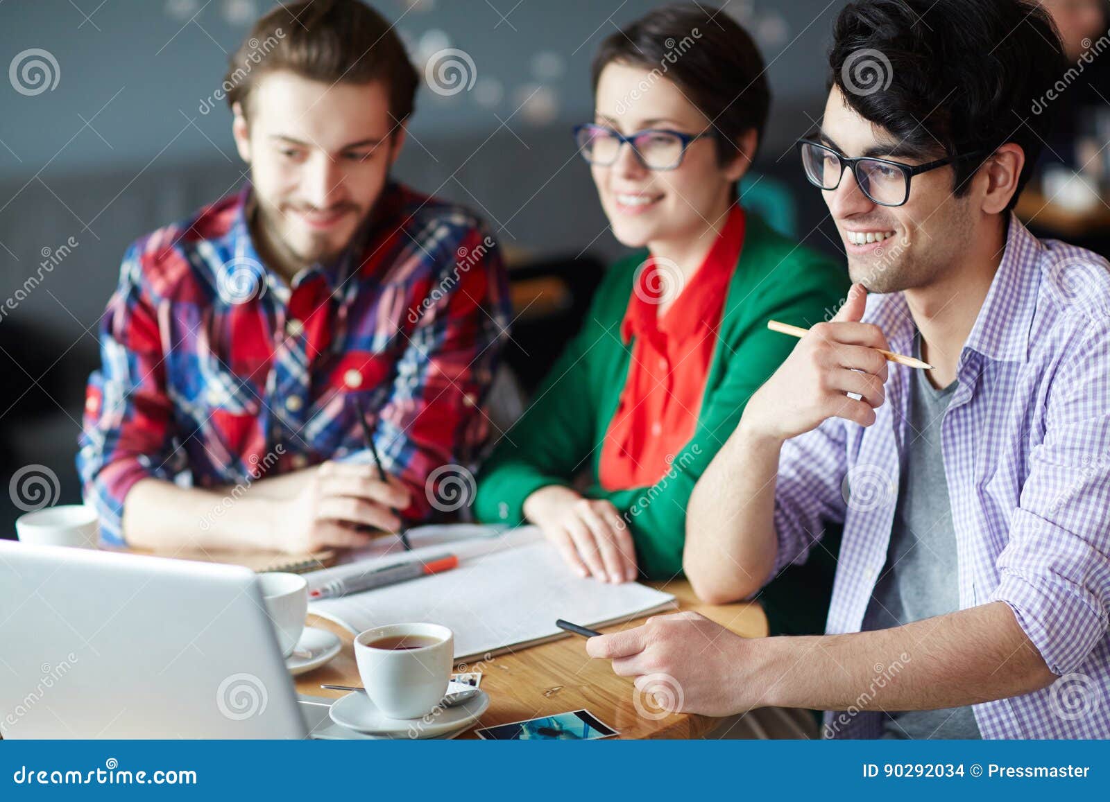 Casual Young People Looking at Laptop Screen Smiling Stock Photo ...