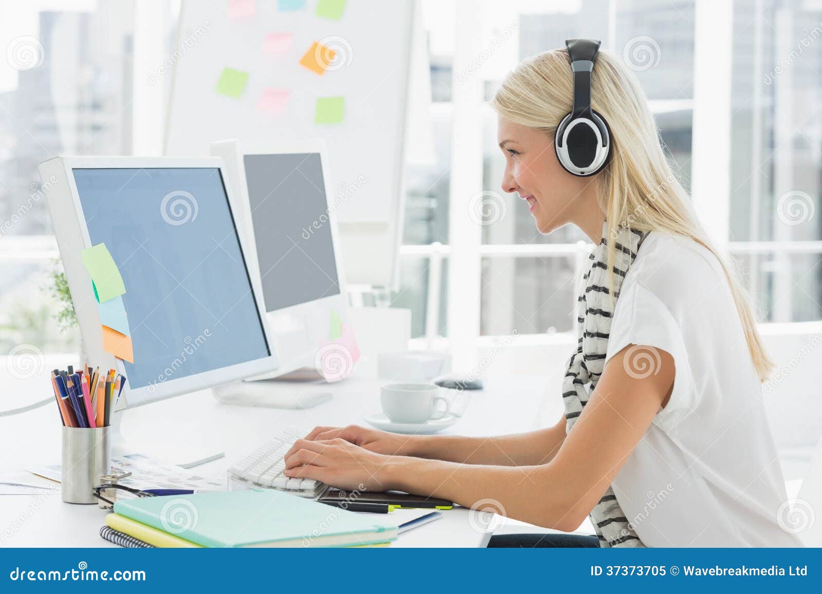 Casual Young Woman with Headset Using Computer in Office Stock Image ...