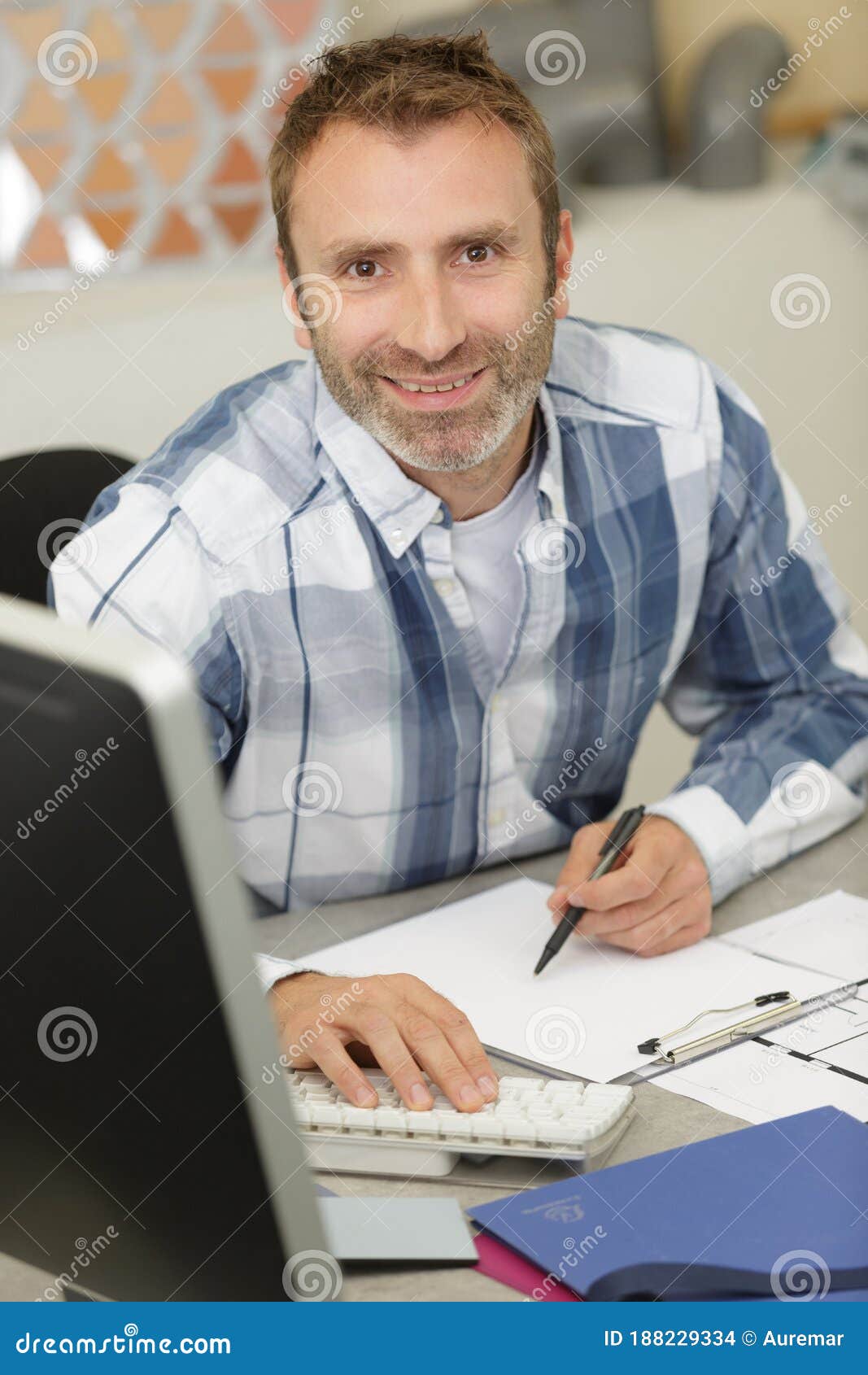 Casually Dressed Man Sat at Desk Using Computer Stock Photo - Image of ...