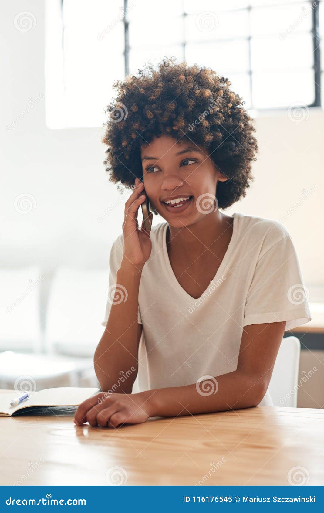 Young African Female Student Smiling while Talking on Her Cellphone ...