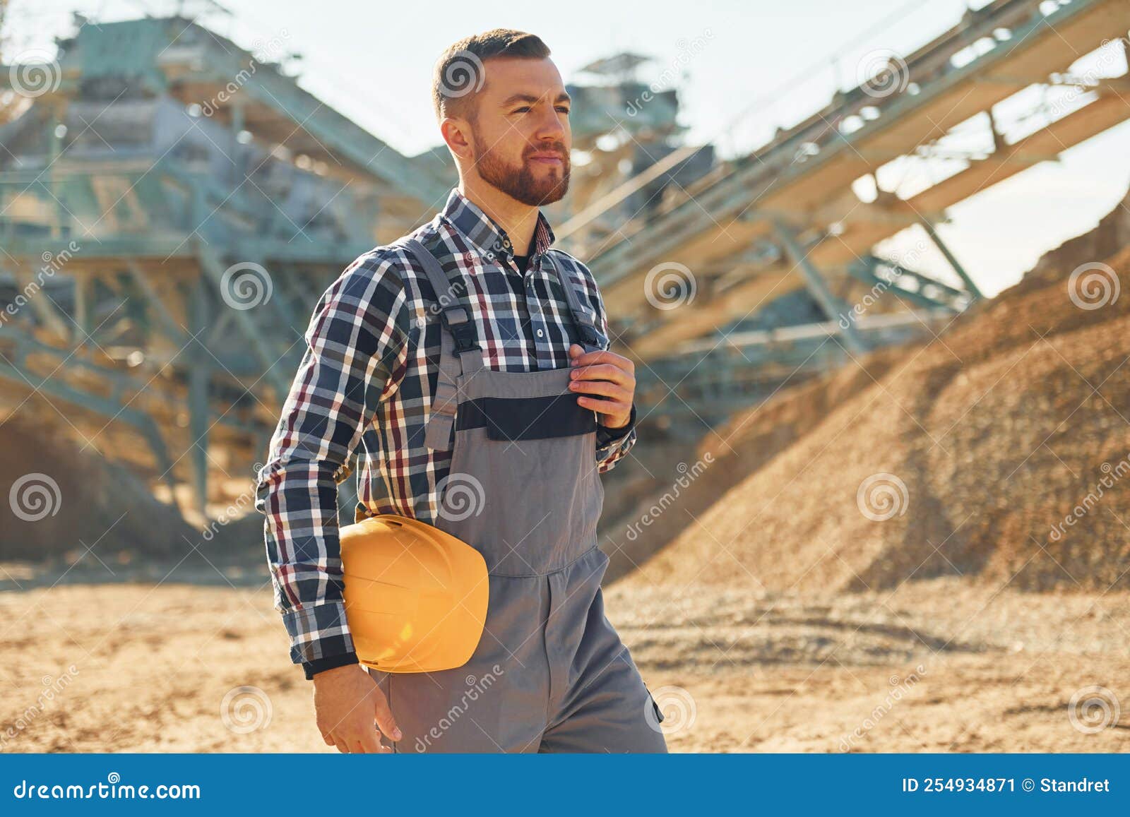 Casually Walking. Construction Worker in Uniform is on the Quarry Stock ...