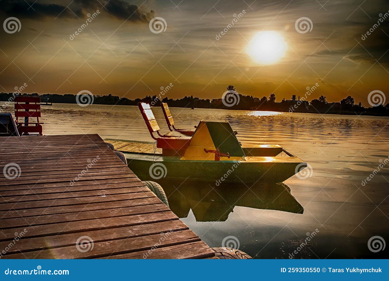 Catamaran at Sunset Near the Pier. Catamaran on the Lake Stock Photo ...