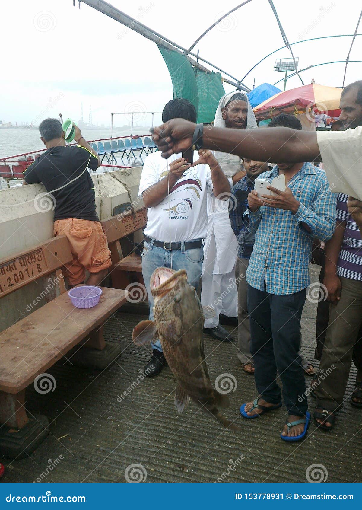 Unique way to catch fish editorial photo. Image of bridge - 153778931