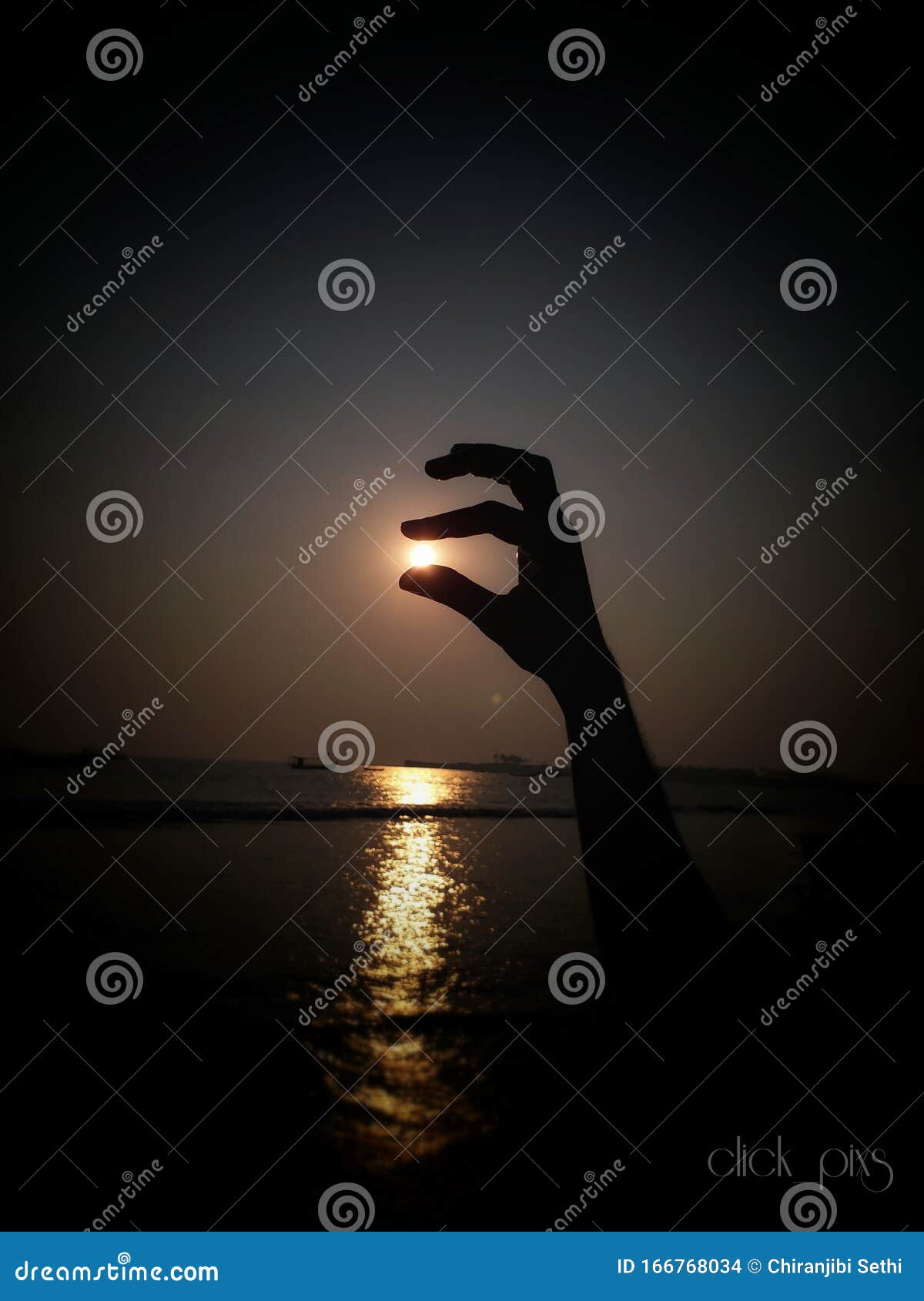 Catching sun with fingers stock photo. Image of holding - 166768034