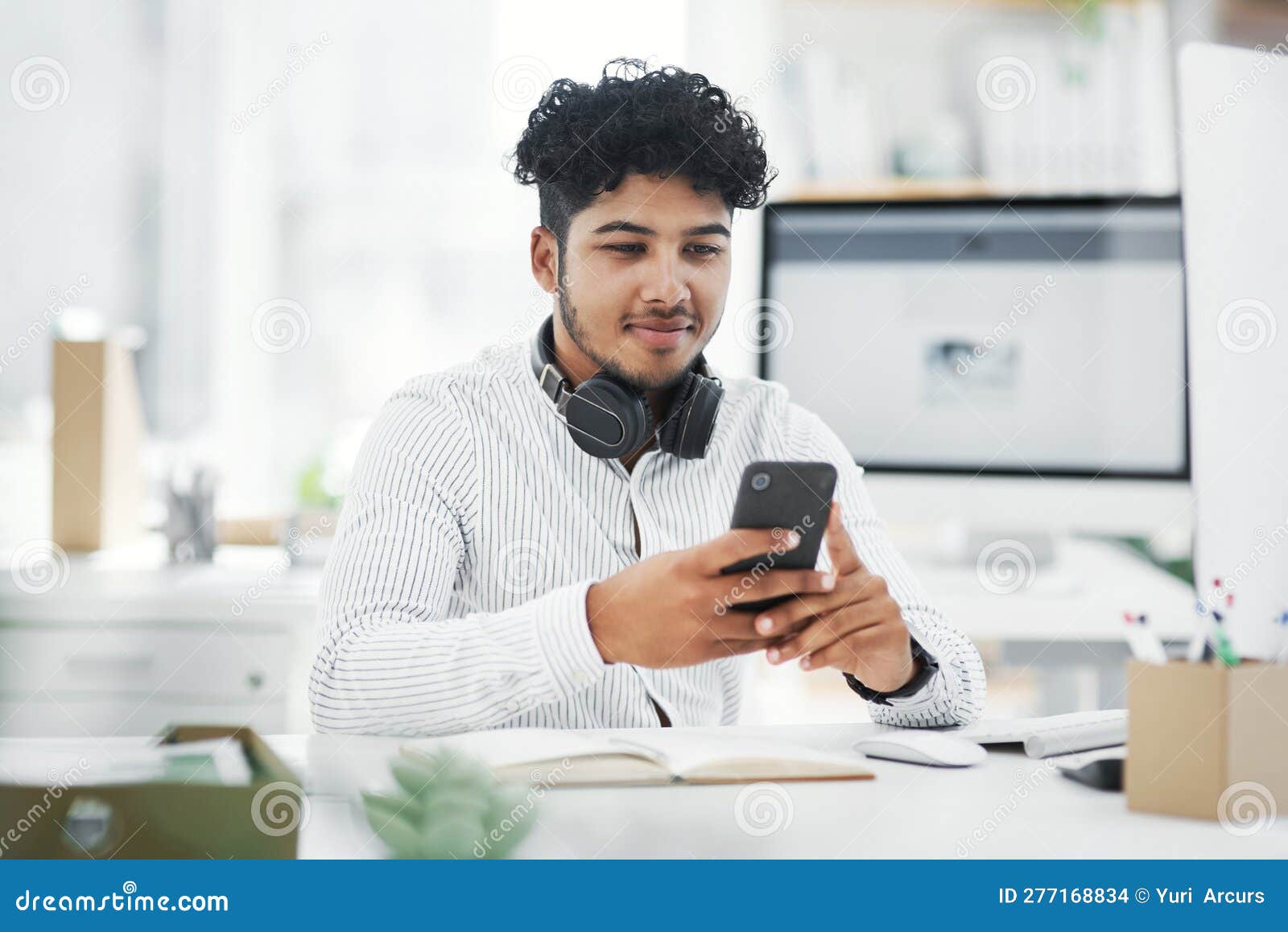 Catching Up between Work. a Young Businessman Using a Cellphone in an ...