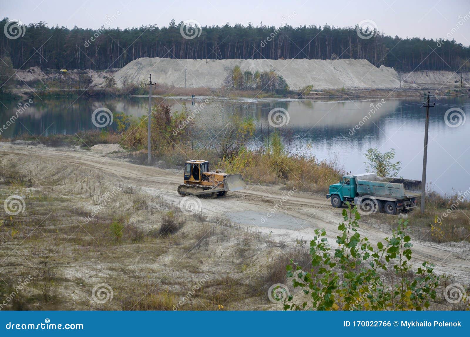 Caterpillar Loader and Dump Truck Works at the Opencast Mining Quarry ...