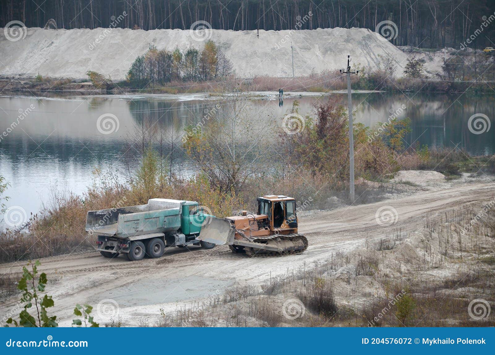 Caterpillar Loader and Dump Truck Works at the Opencast Mining Quarry ...