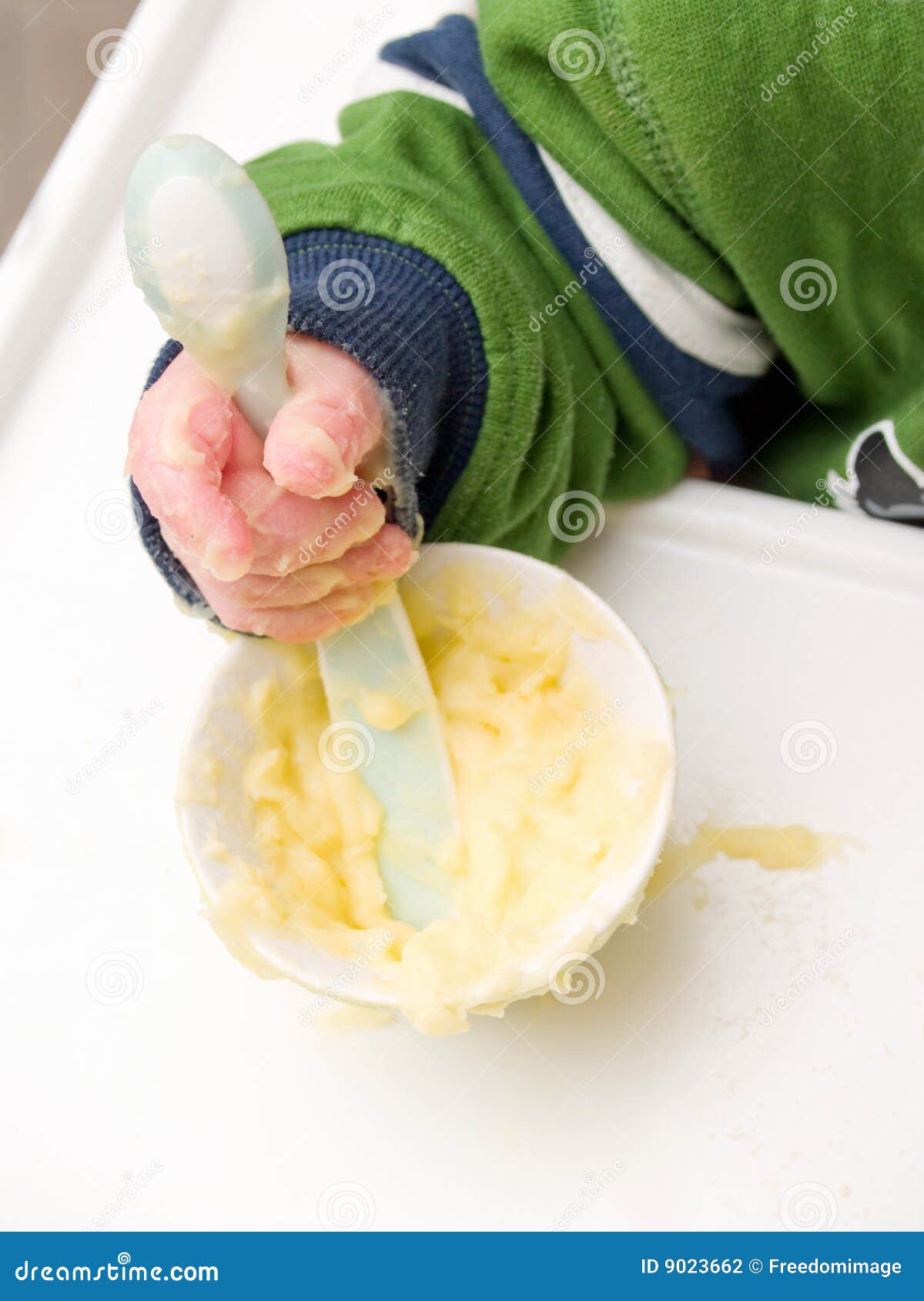 Caucasian Baby S Hand Using Spoon To Eat Stock Photo - Image of green ...