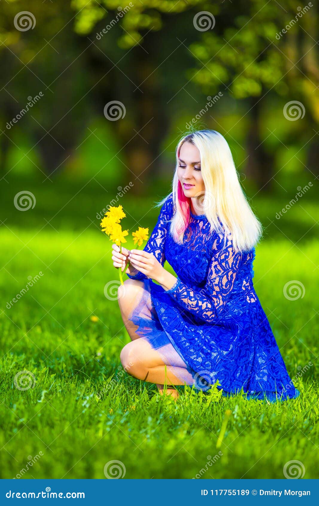 Caucasian Blond Girl Picking Up Flowers For Bunch Of Daffodils Stock