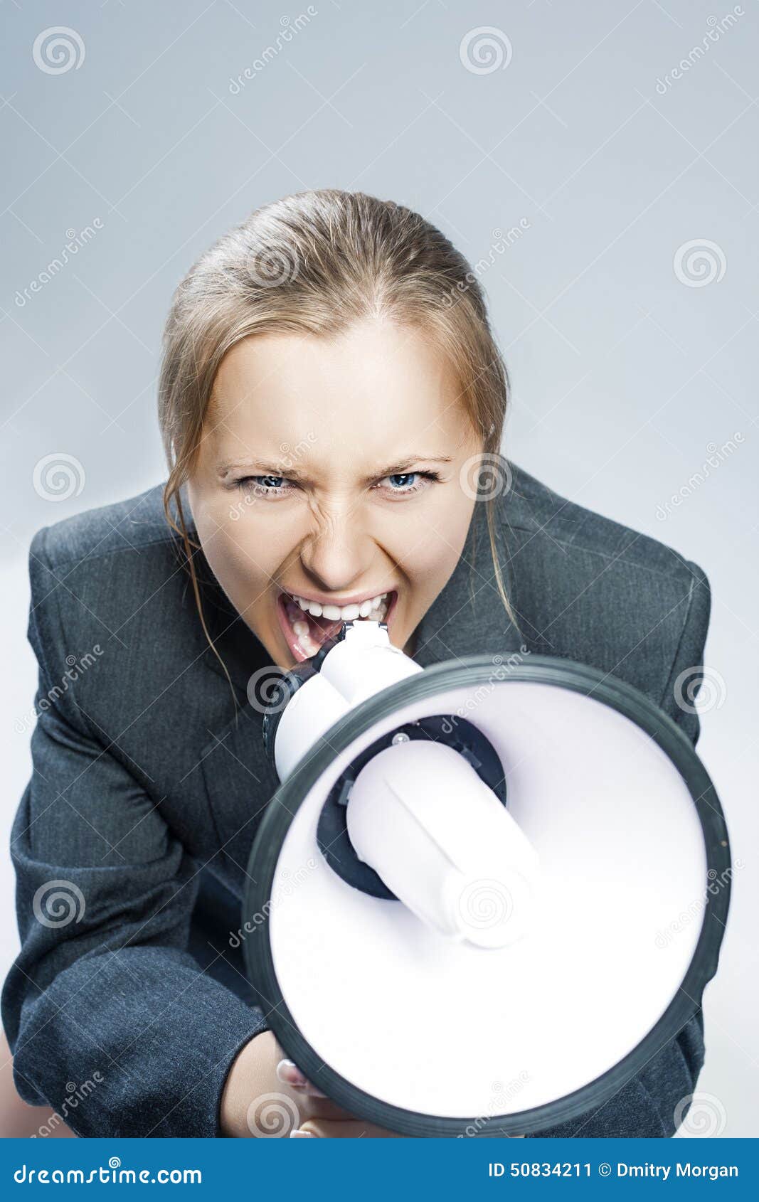 Caucasian Blond Woman Shouting Using Megaphone. Against Grey Background ...