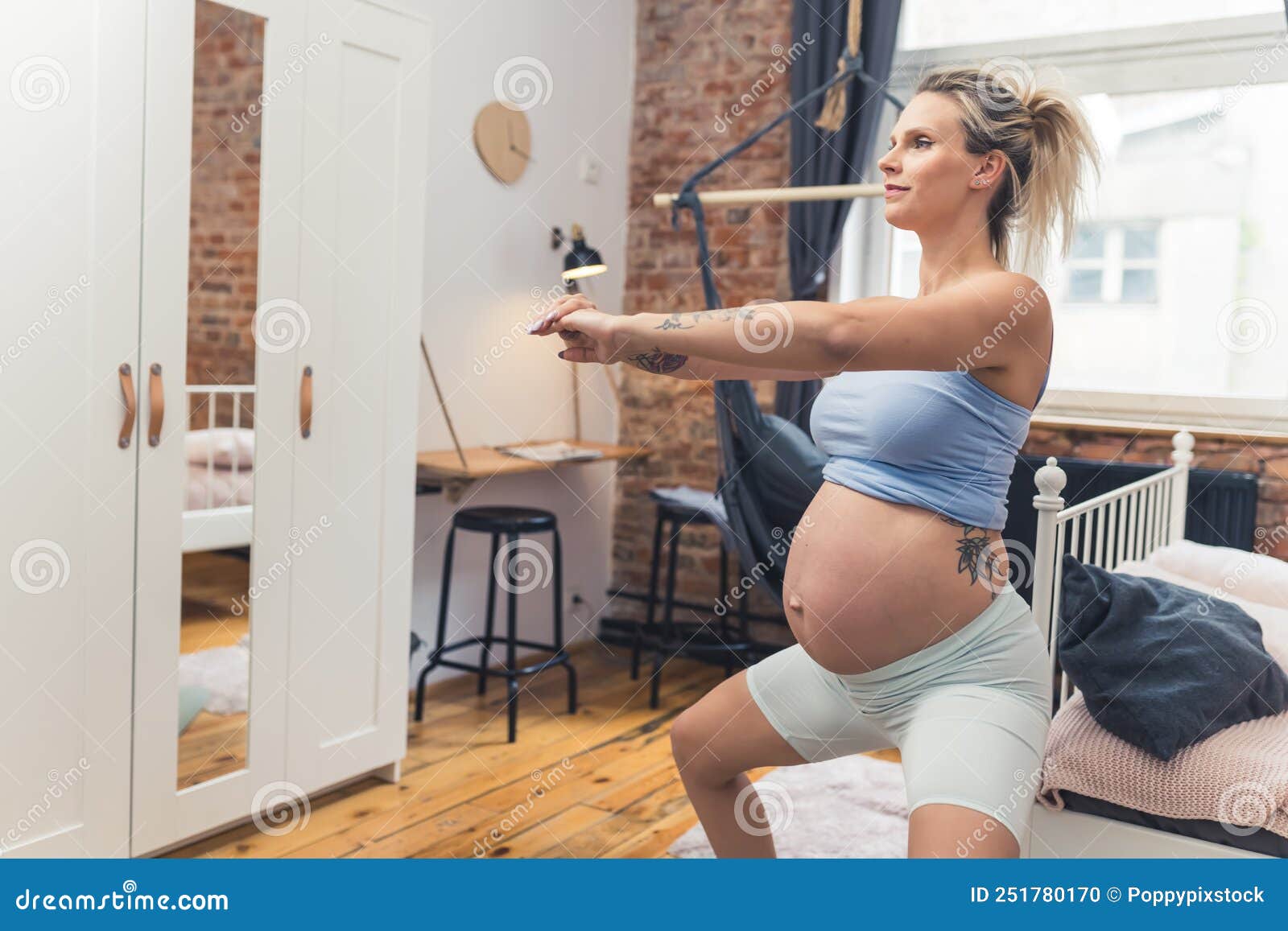 Caucasian Blonde Pregnant Woman In Her 30s Wearing White Biker Shorts