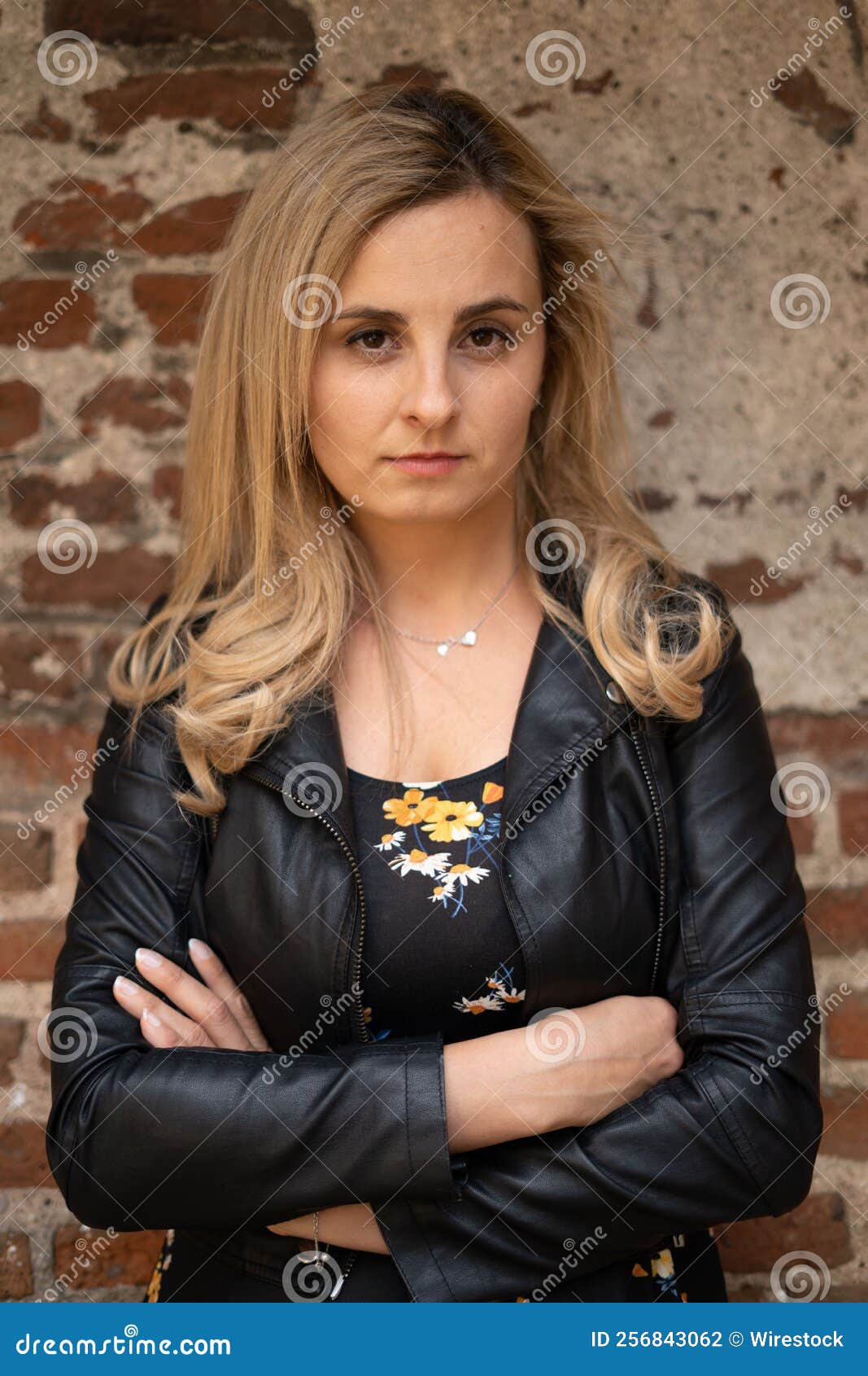 Caucasian Blonde Woman From Uk Posing In Front Of A Brick Wall Stock