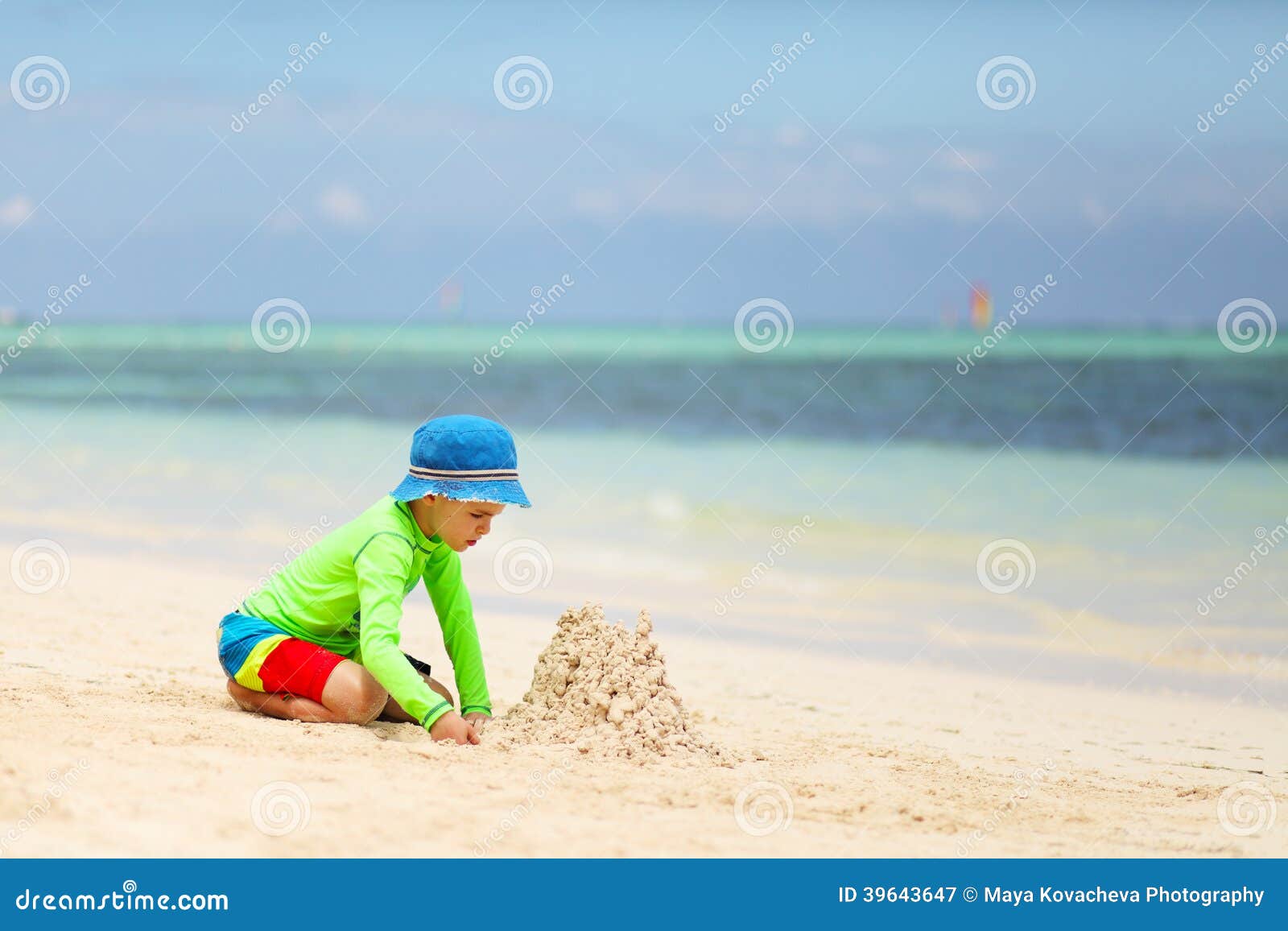 Caucasian Boy Building Sand Castle on Tropical Beach Stock Image ...