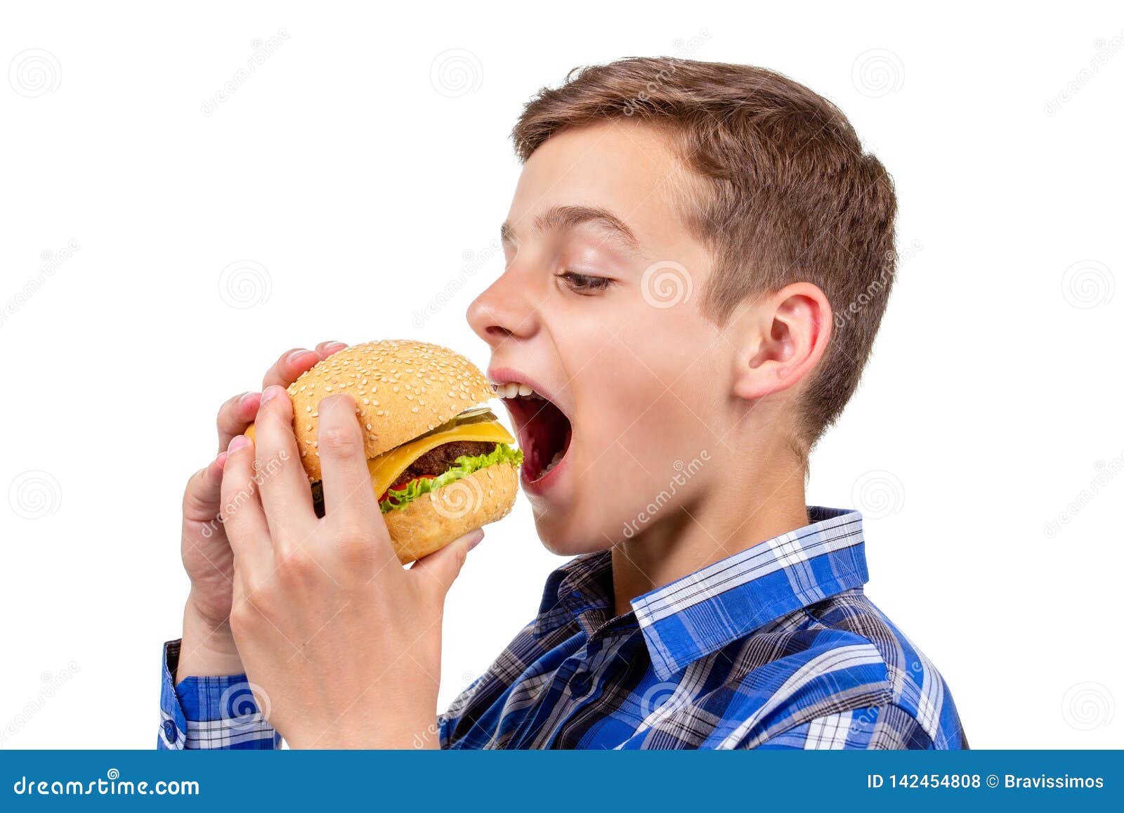 Caucasian Boy Eating Burger and Hamburger on White Background, Bun ... Caucasian Boy Eating Burger and Hamburger on White Background, Bun ...