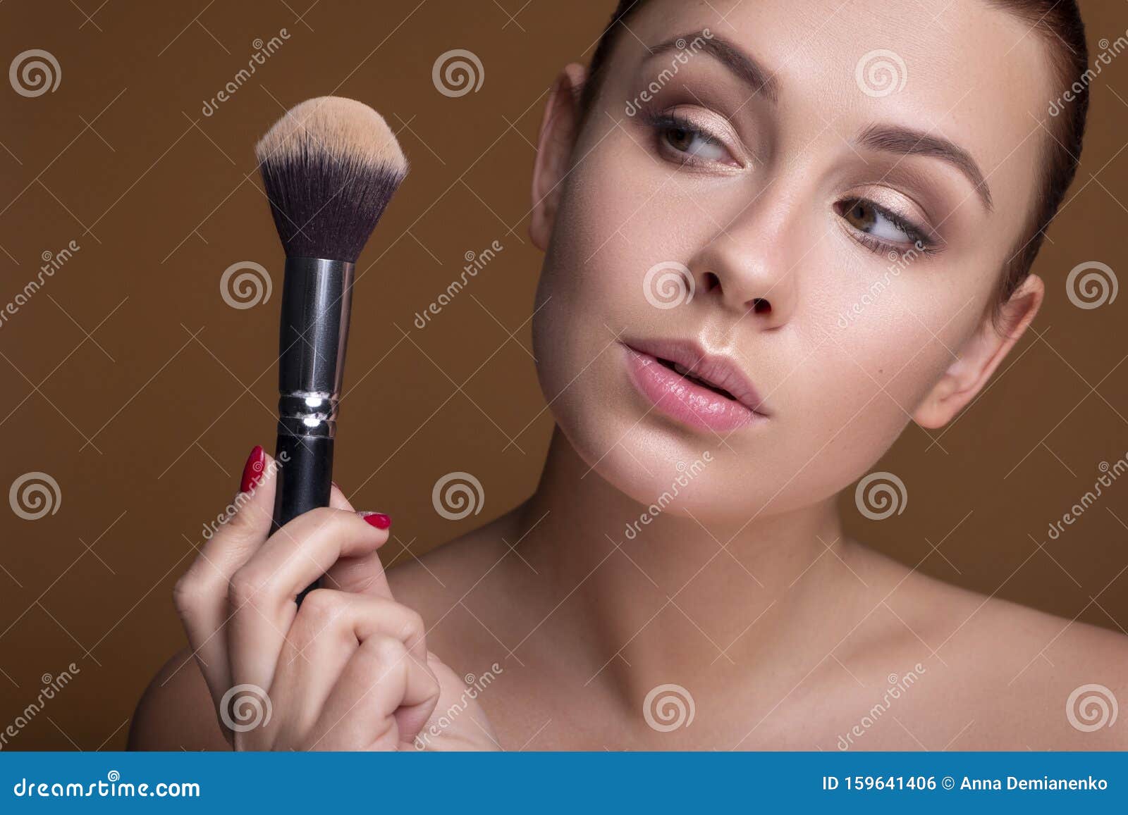 Caucasian Brunette Woman Apply Blush On A Cheekbone With A Brush Close