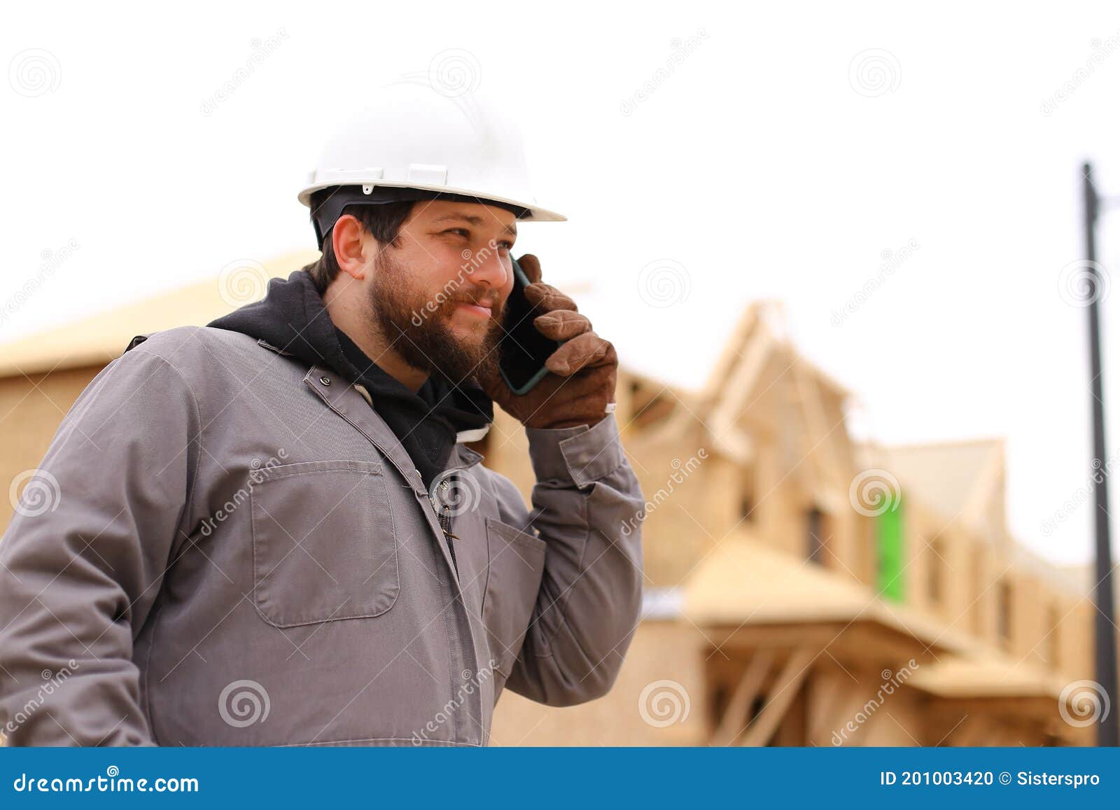 Caucasian Builder Talking by Smartphone at Construction Site. Stock ...
