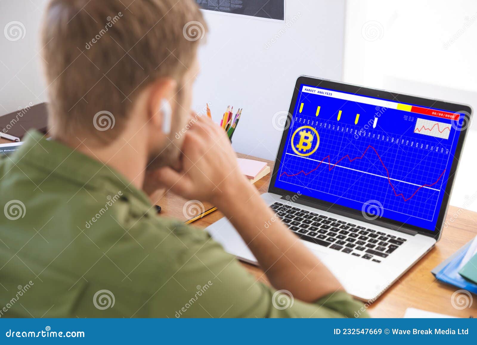 Caucasian Businessman Sitting at Desk, Using Laptop with Statistical ... Caucasian Businessman Sitting at Desk, Using Laptop with Statistical ...
