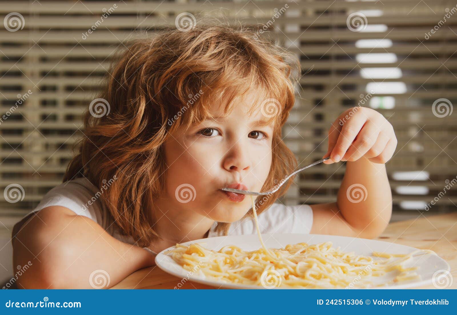 Caucasian Child Eating Pasta, Spaghetti. Kids Funny Face. Stock Photo ...