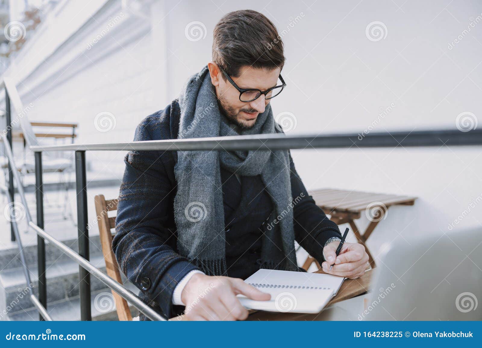 Caucasian Concentrated Man Is Making Notes Outdoors Stock Image Image