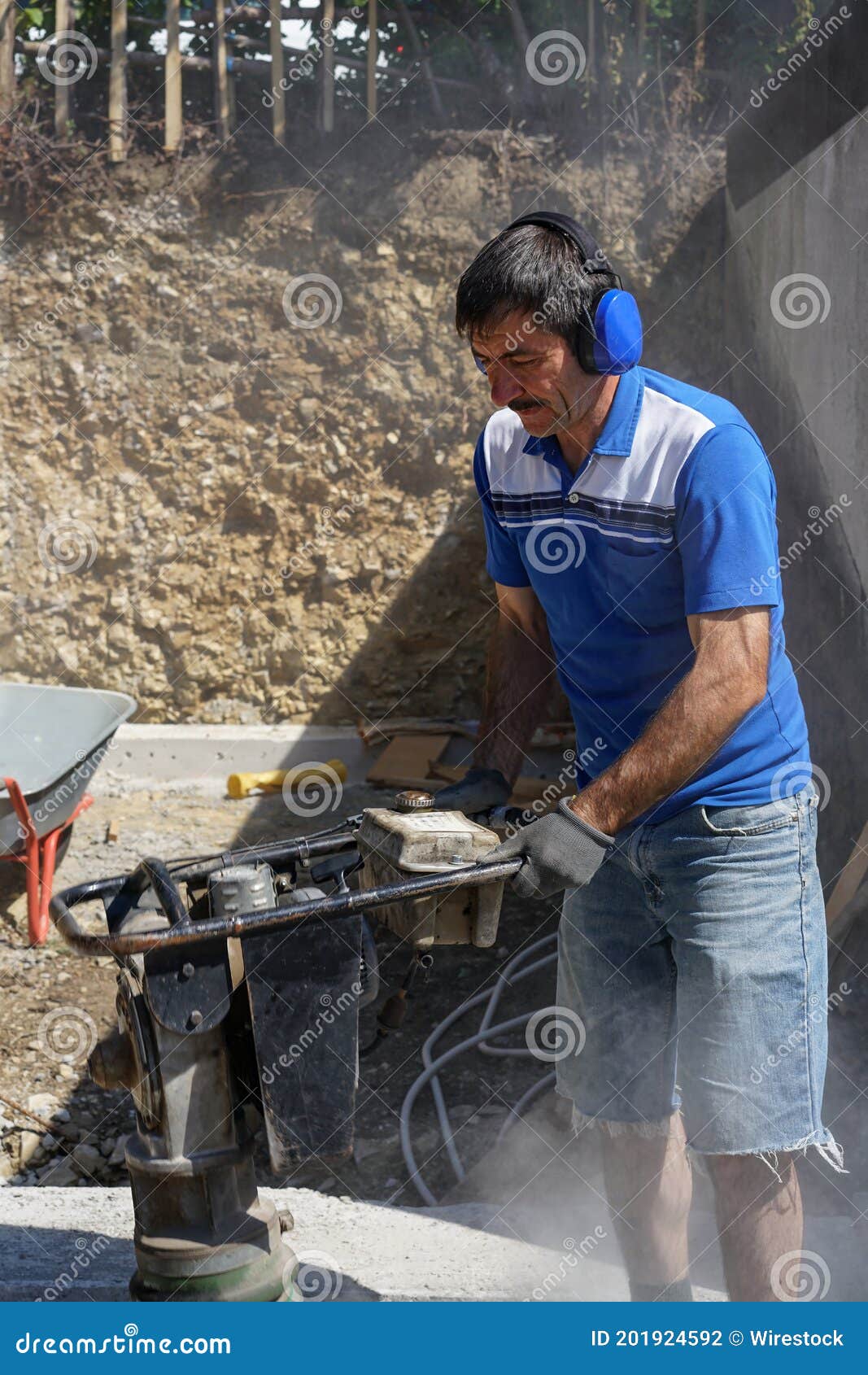 Caucasian Construction Worker Compacting Soil Using a Tamping Rammer ... Caucasian Construction Worker Compacting Soil Using a Tamping Rammer ...