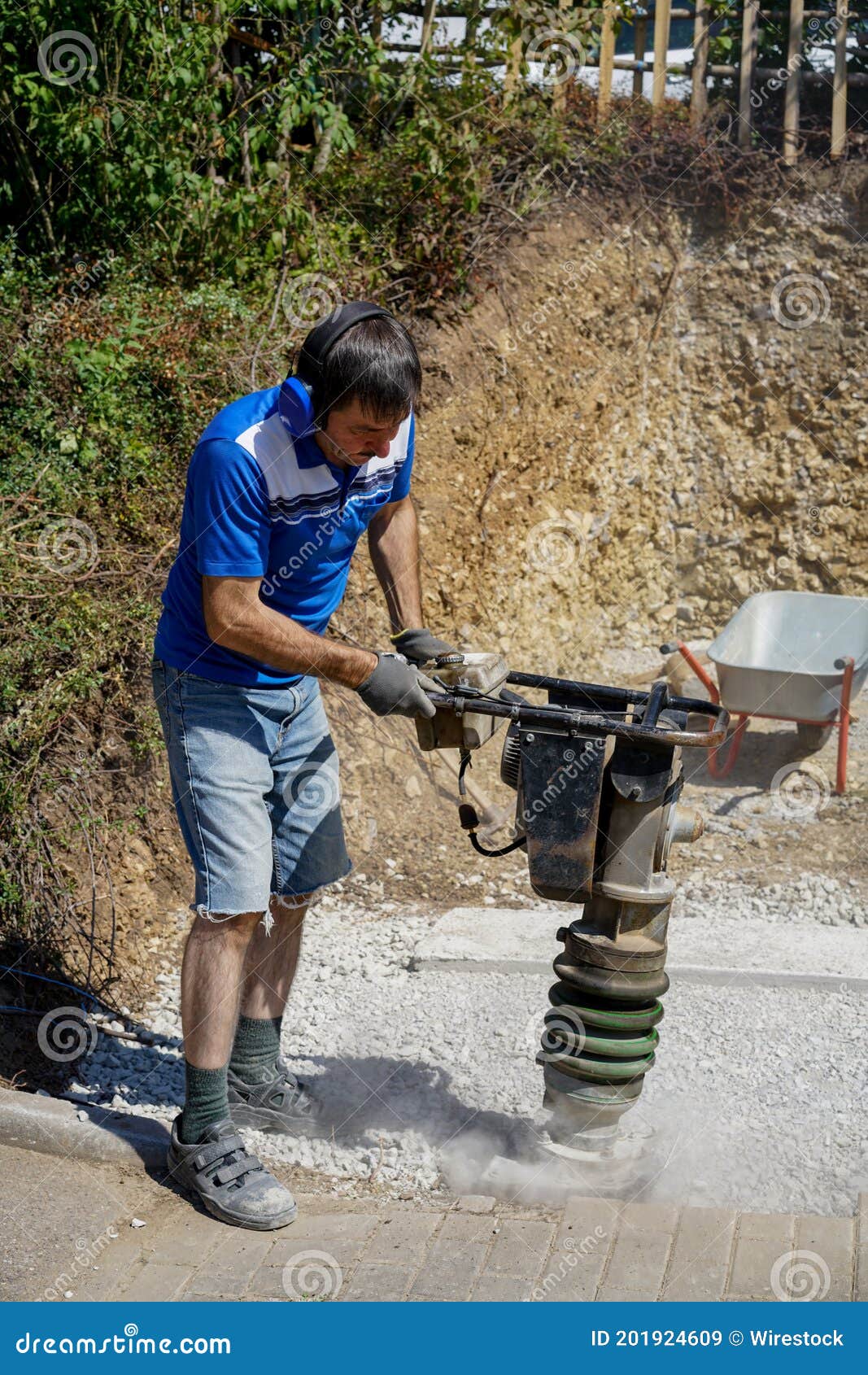Caucasian Construction Worker Compacting Soil Using a Tamping Rammer ...