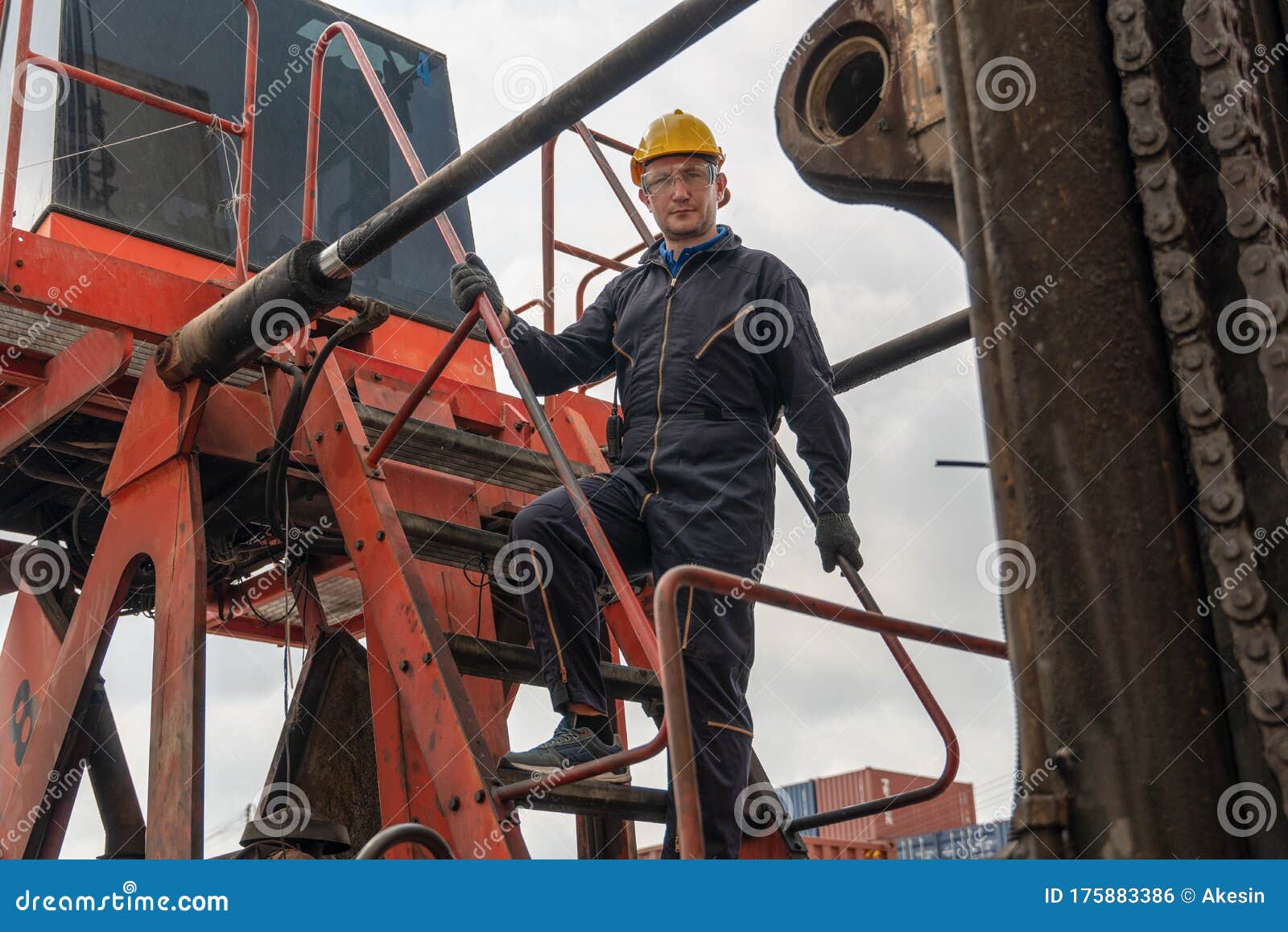 Caucasian Engineer and Heavy Machine Operator with Container Forklift ...
