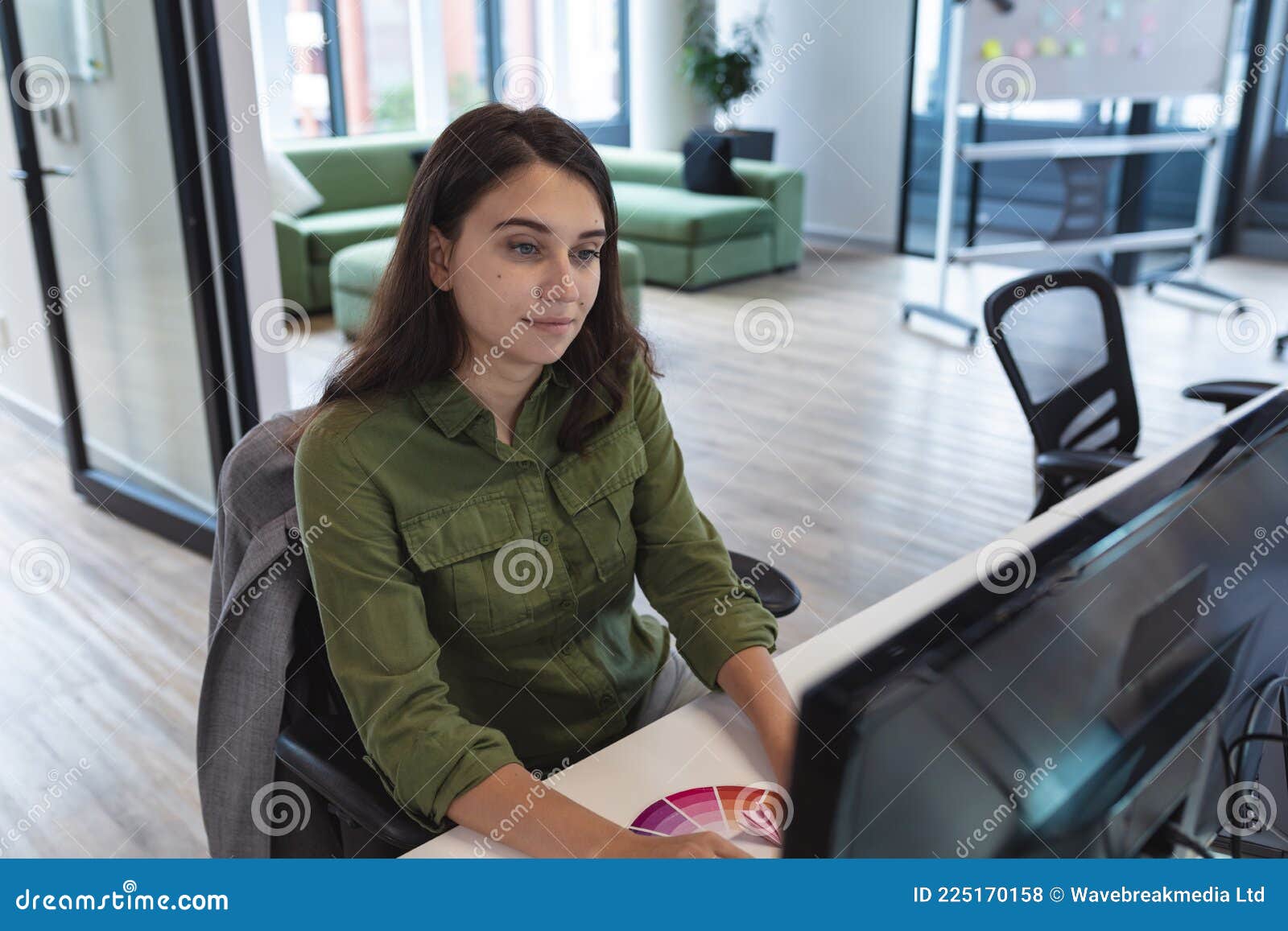 Caucasian Female Creative Worker Sitting at Desk Using Computer Stock ...