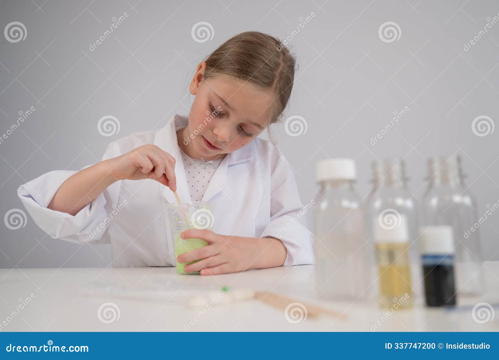 Caucasian Girl Doing Chemical Experiments on a White Background. Making ...