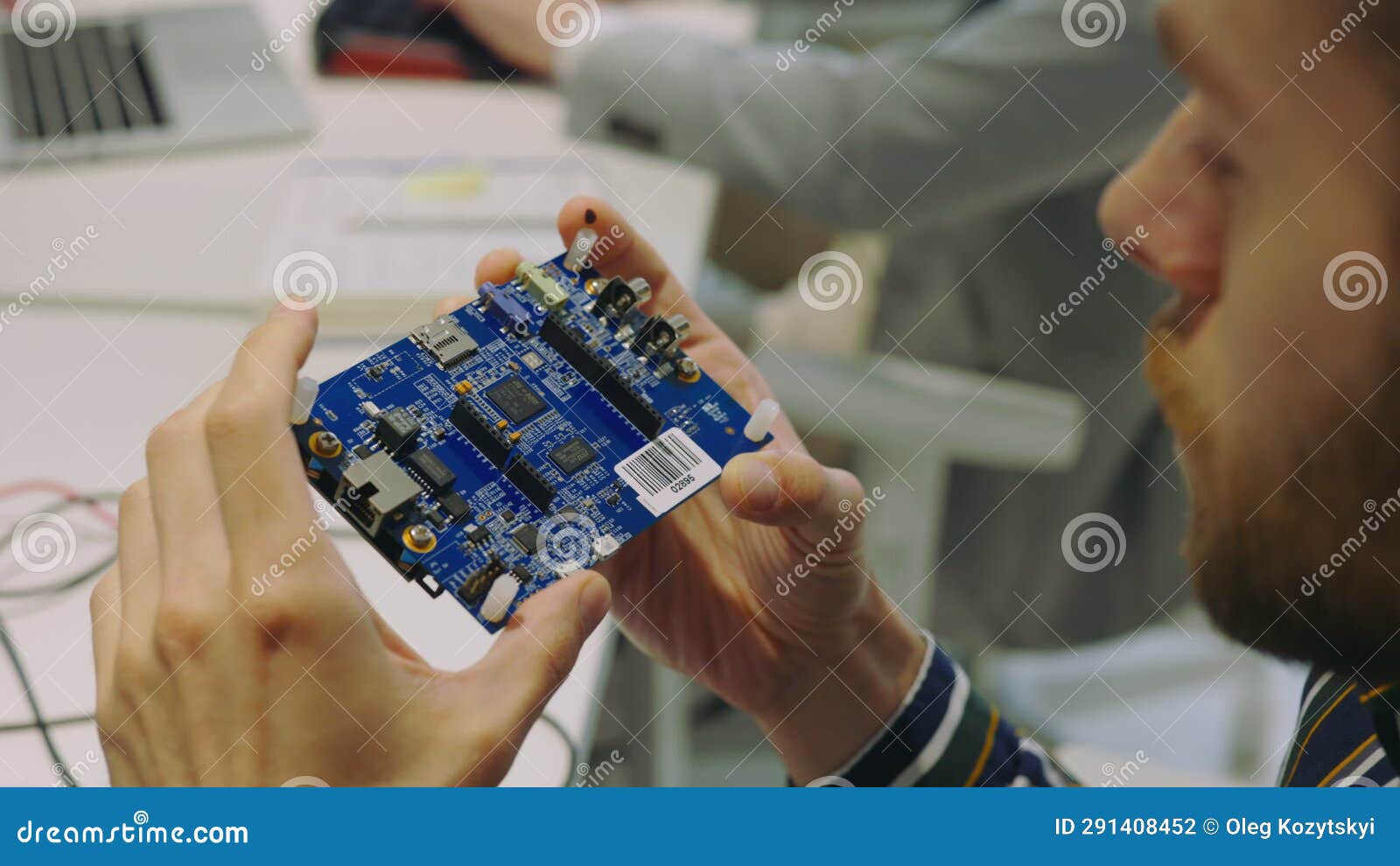 Caucasian Handsome Guy Engineer Checking the Motherboard. Male Holding ...