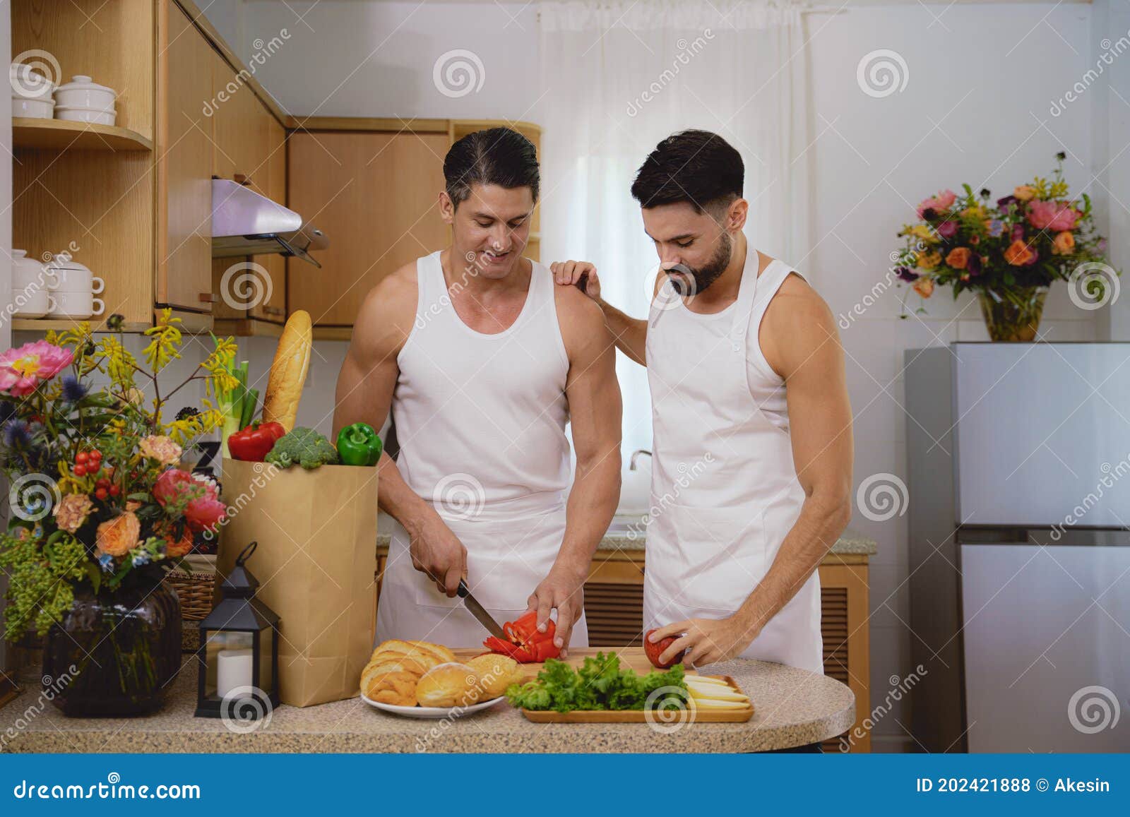 Caucasian Lgbtq Gay Couple Enjoying Cooking Food Together In Kitchen