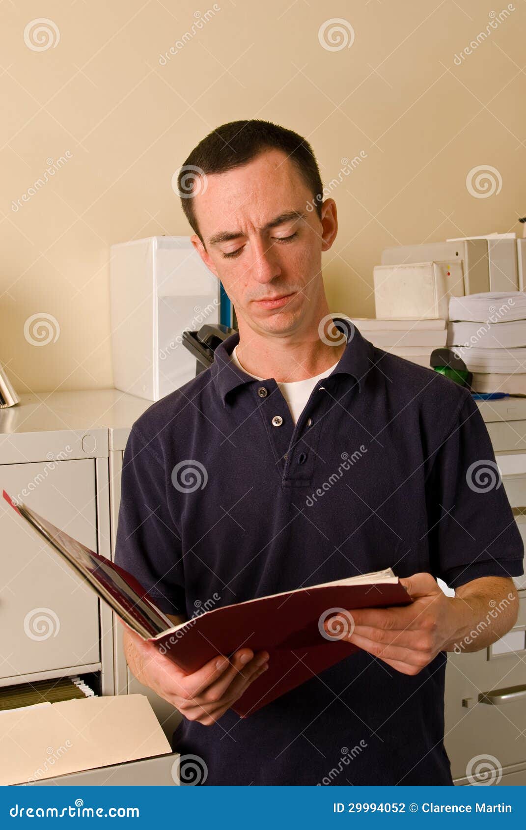 Caucasian Male in File Room Reading Papers Inside a Folder Stock Photo ...