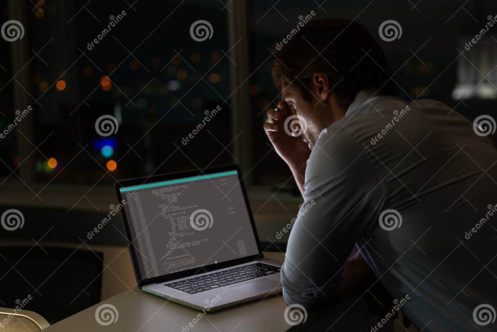 Caucasian Male Programmer Sitting at Desk, Using Laptop with Coding on Screen Stock Photo ...