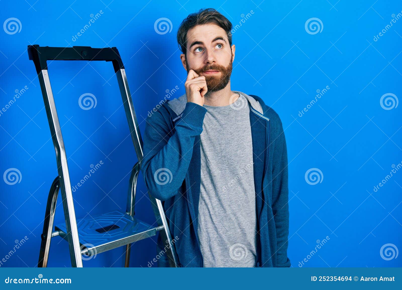 Caucasian Man with Beard by Ladder Serious Face Thinking about Question ...